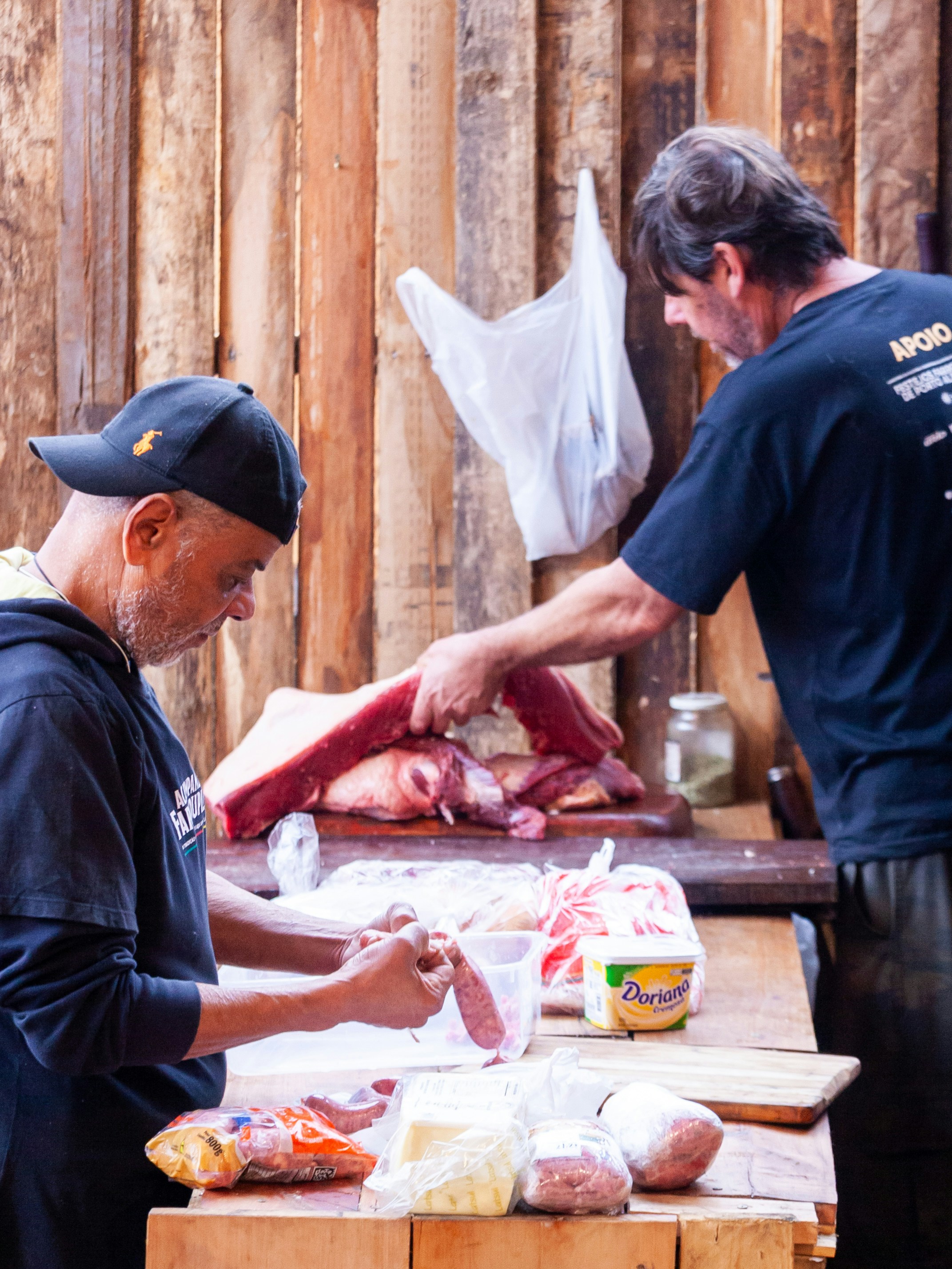 Butcher's Rhythm: Hands at Work Amid Fresh Cuts