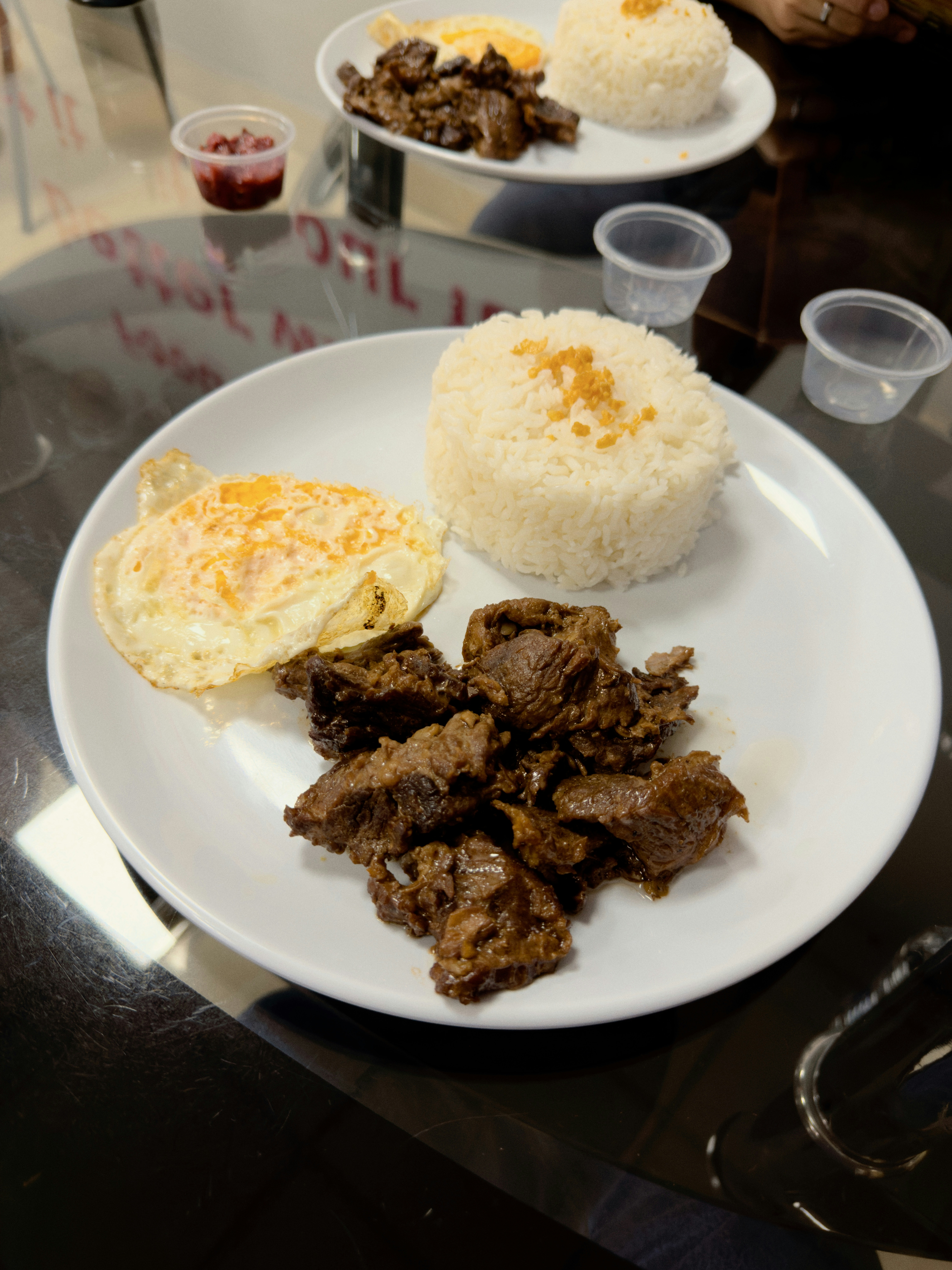 Plate of Rice, Beef, and Egg: Simple Comfort on a Reflective Table