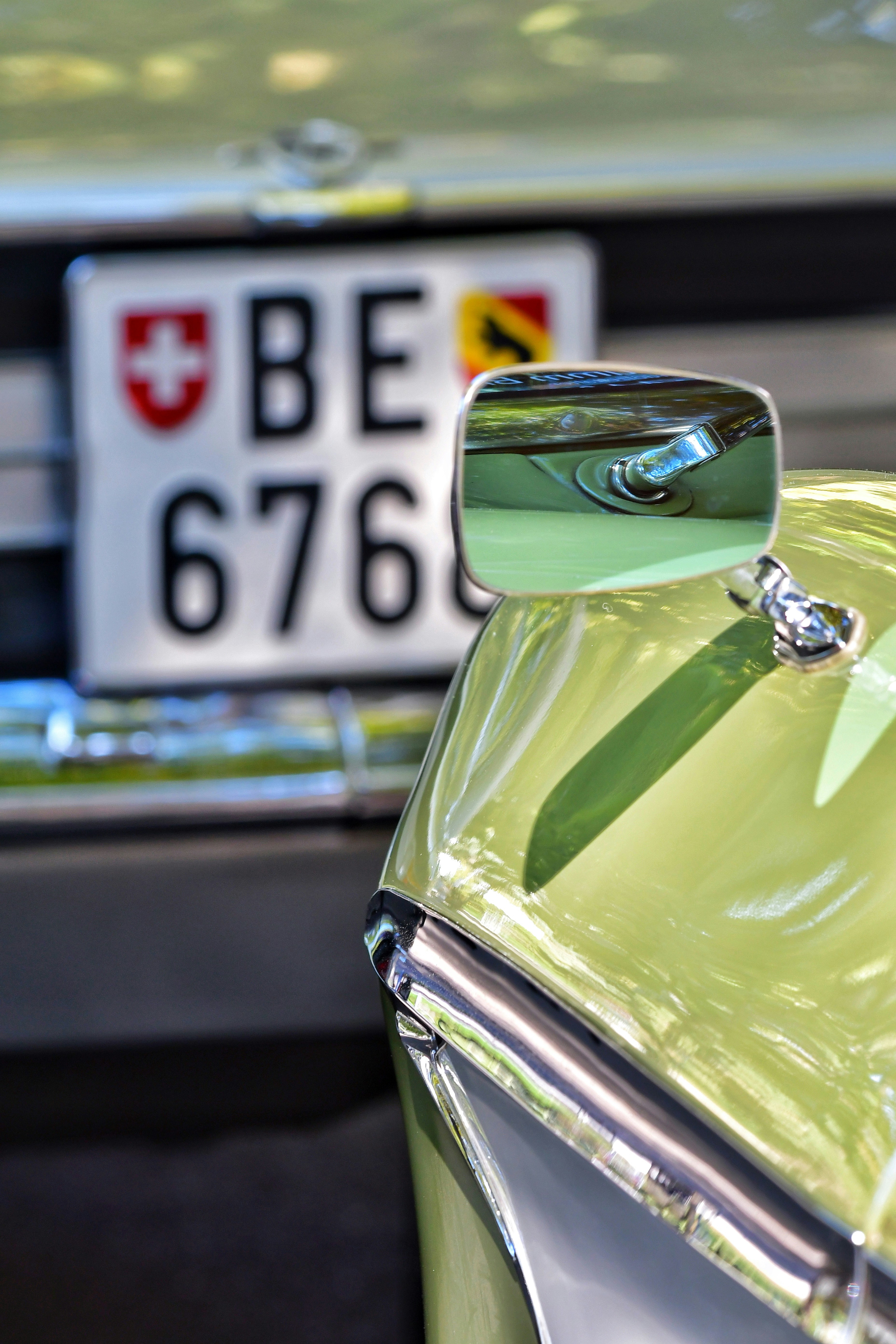 Minted chrome and vintage green: a classic car’s chrome mirror anchors the shot