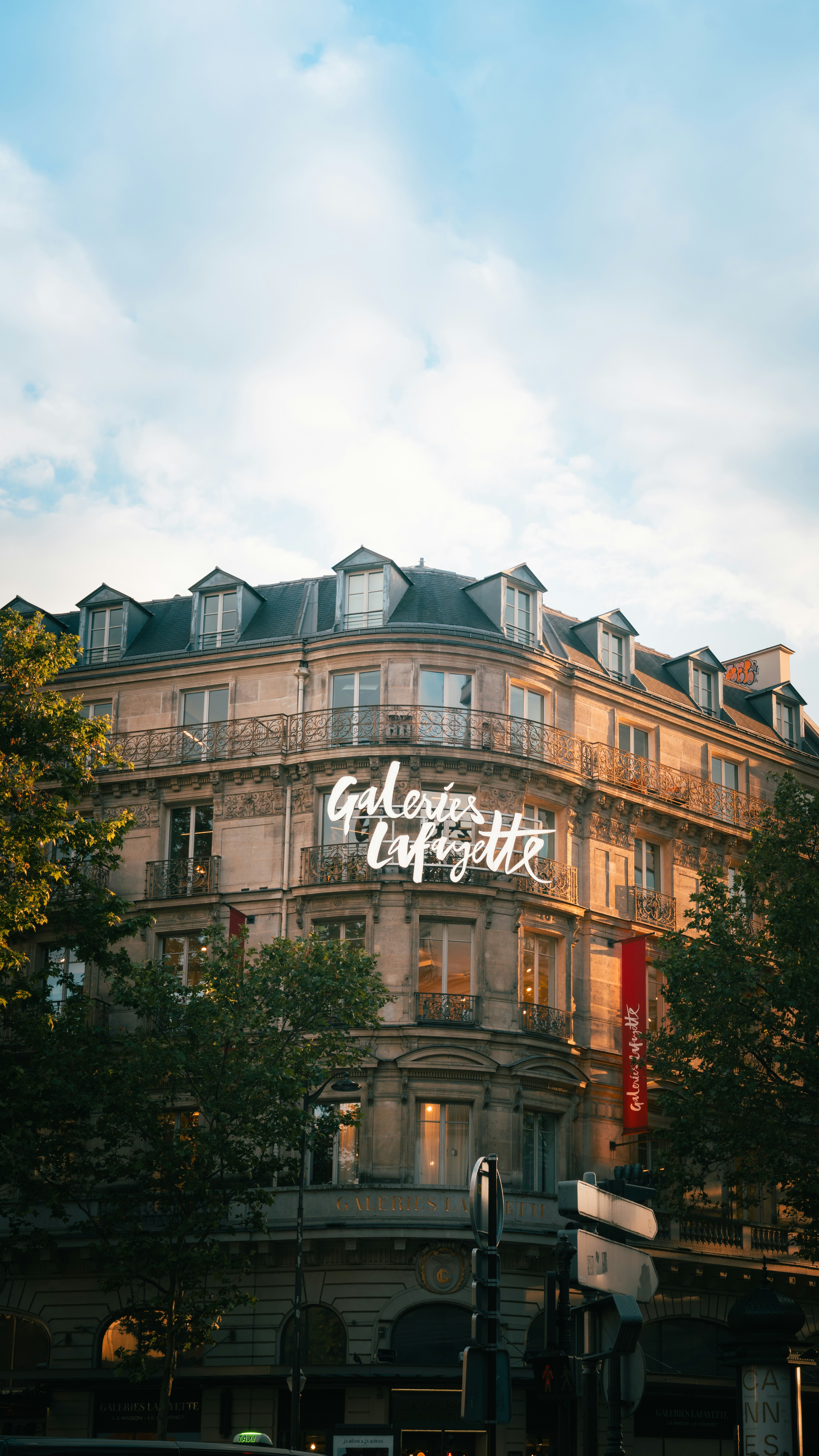 Facade of Galerie Lafayette: Parisian signage under a soft evening sky