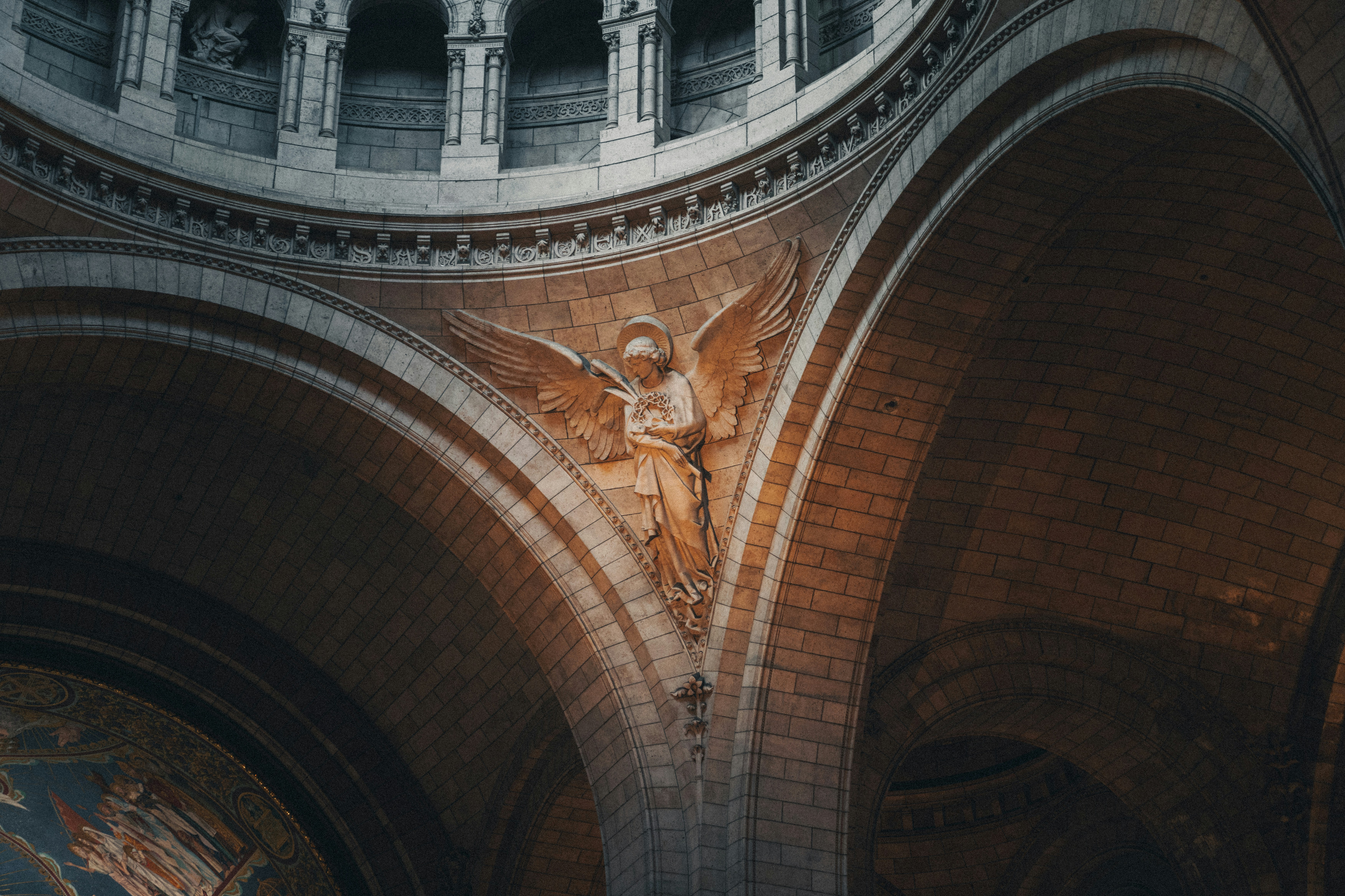 Winged Guardian over the Arch: Angelic Crest in Stone Cathedral