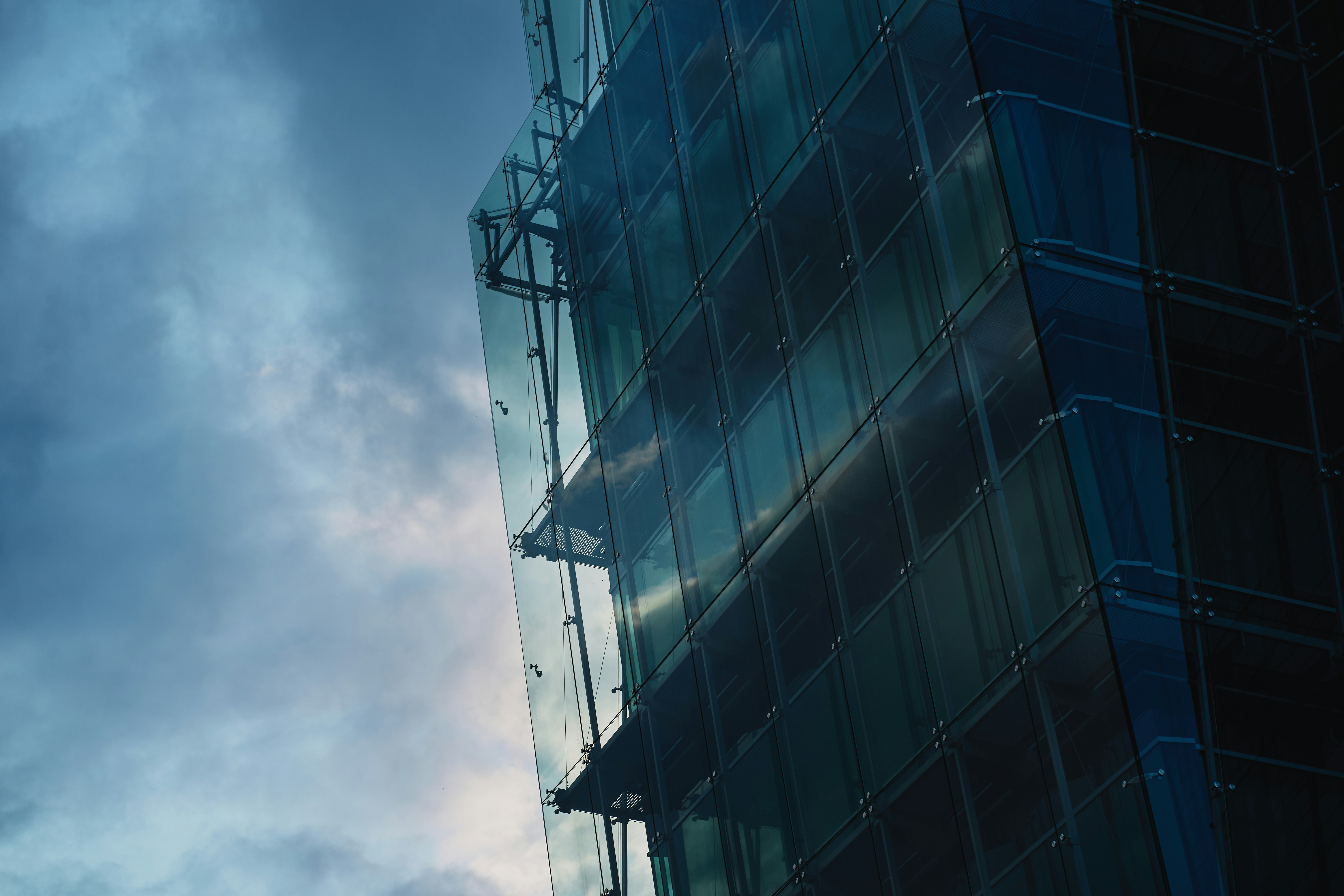 Glassed Facade Ascends into a Skywashed Blue