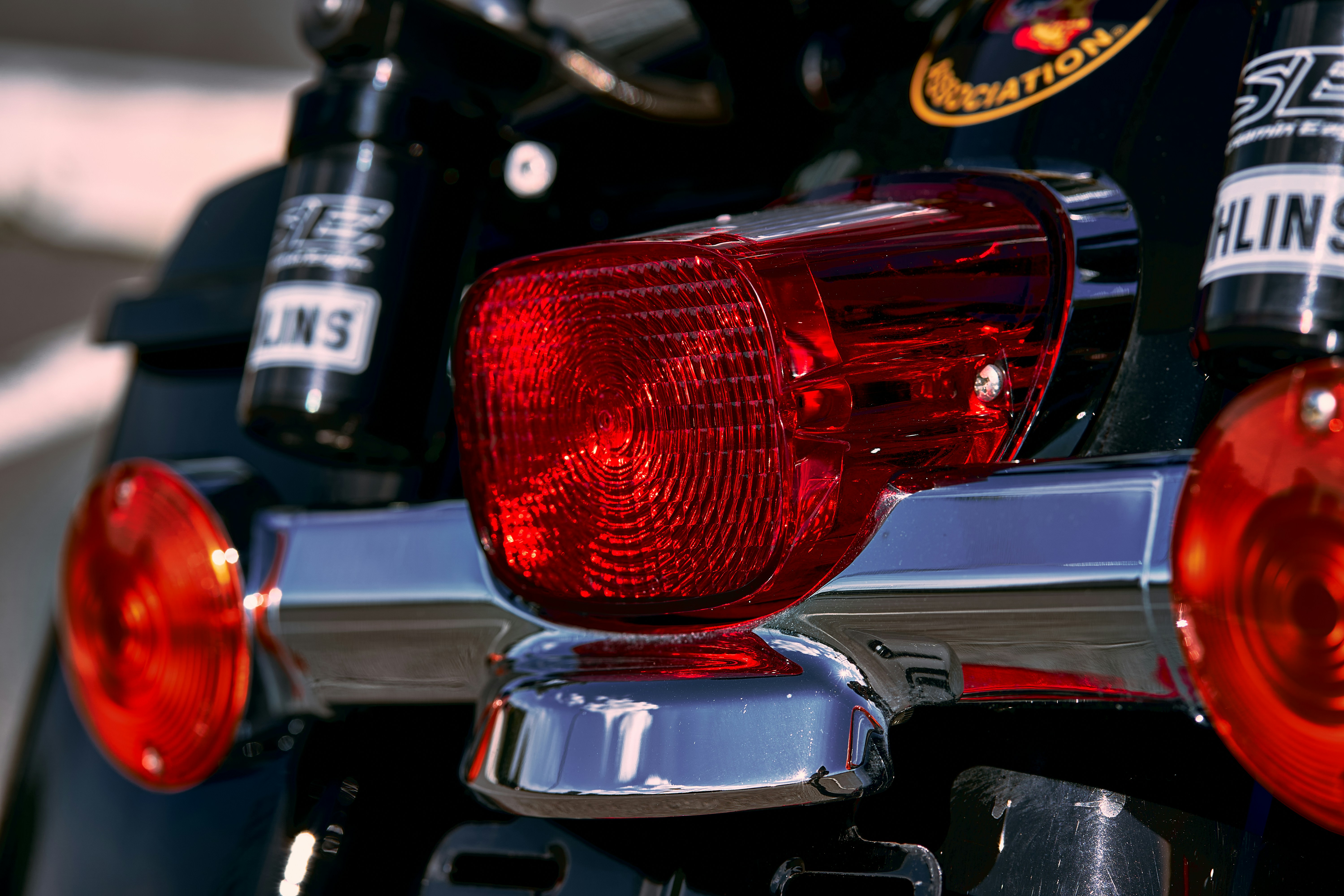 Tail Light Reverie: Chrome and Red in the Night