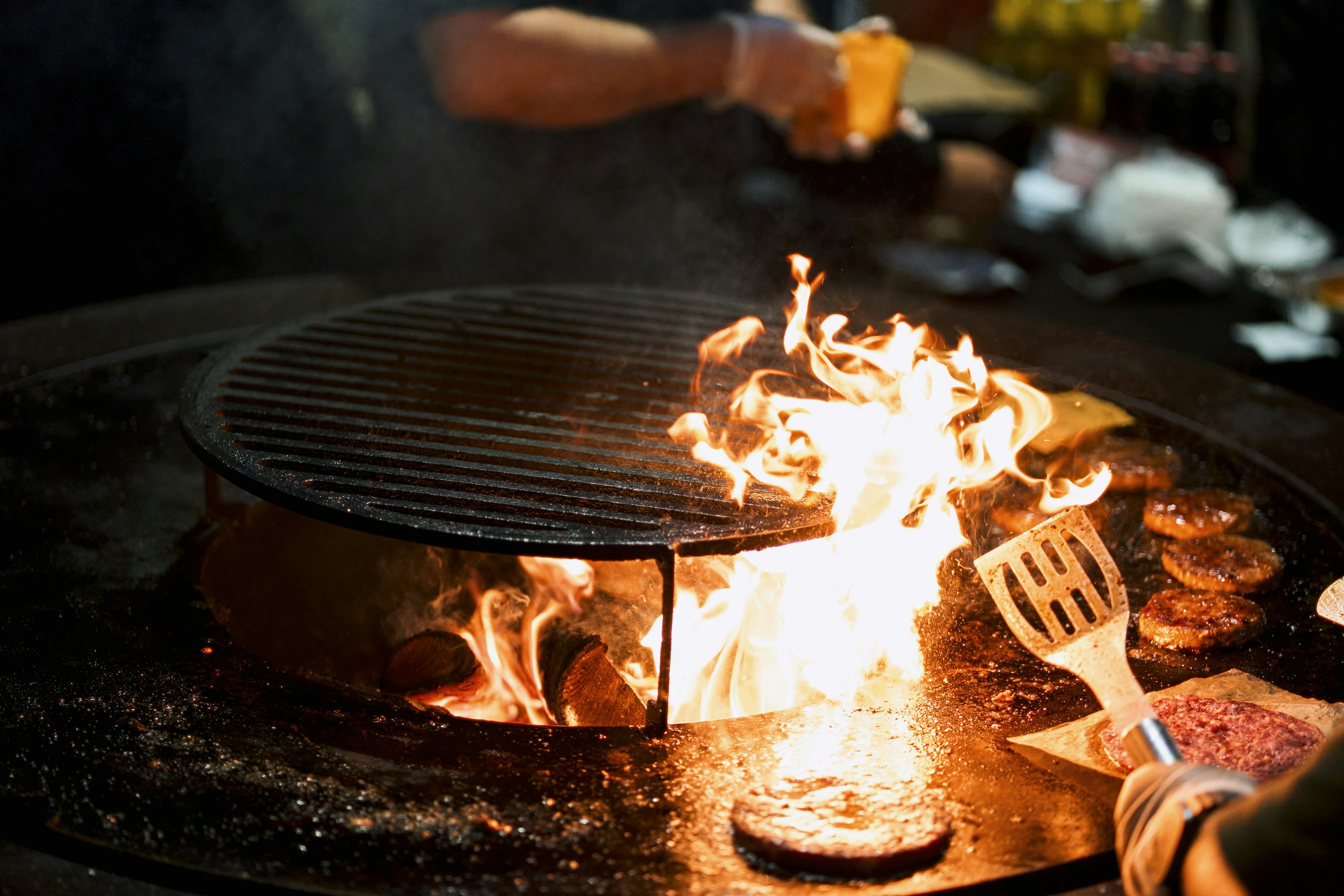 Griddle Blaze: Chef's Hand at the Flame-Burnished Grill