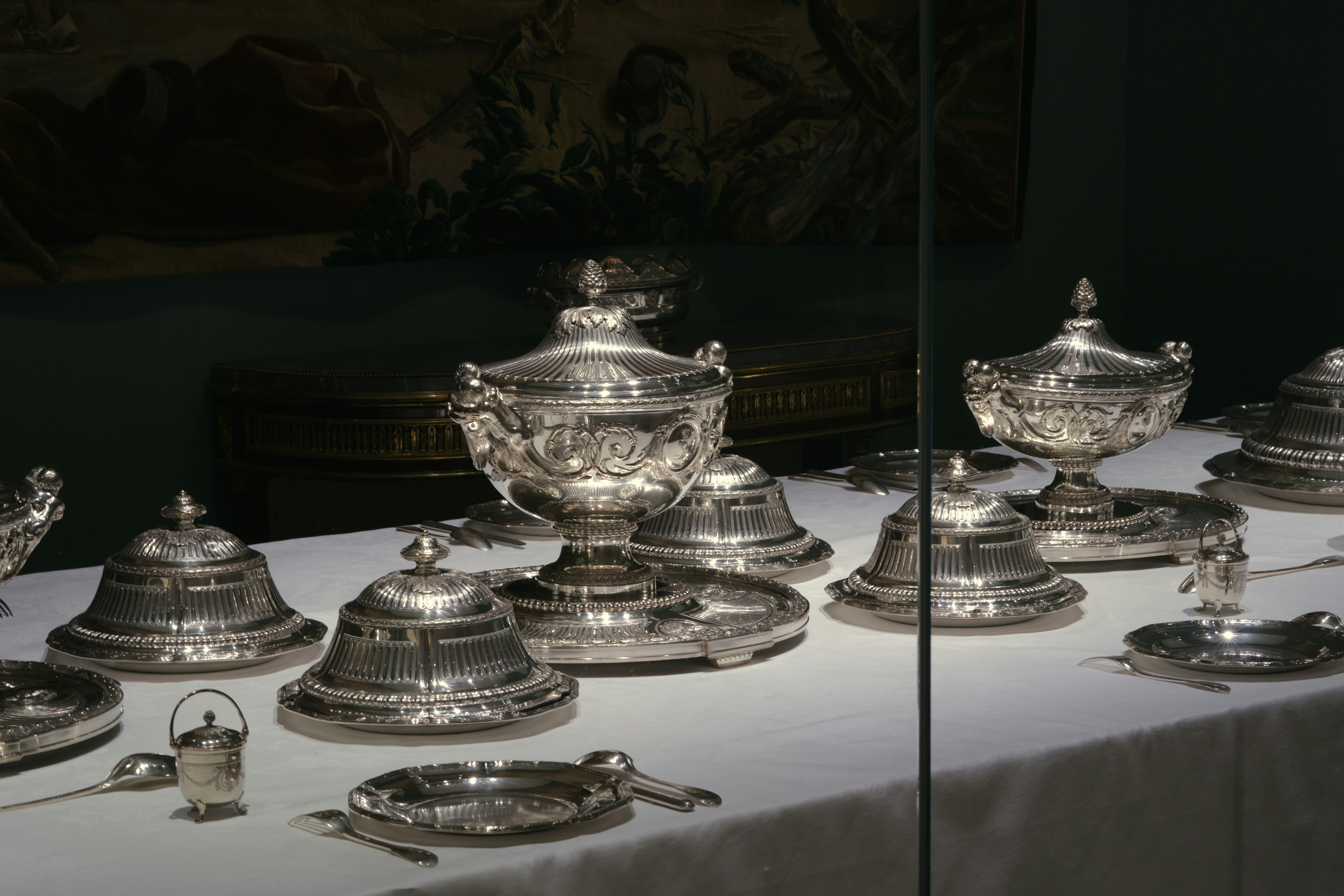 A Quiet Display of Heritage: Silver Serving Pots on a Lustrous Table