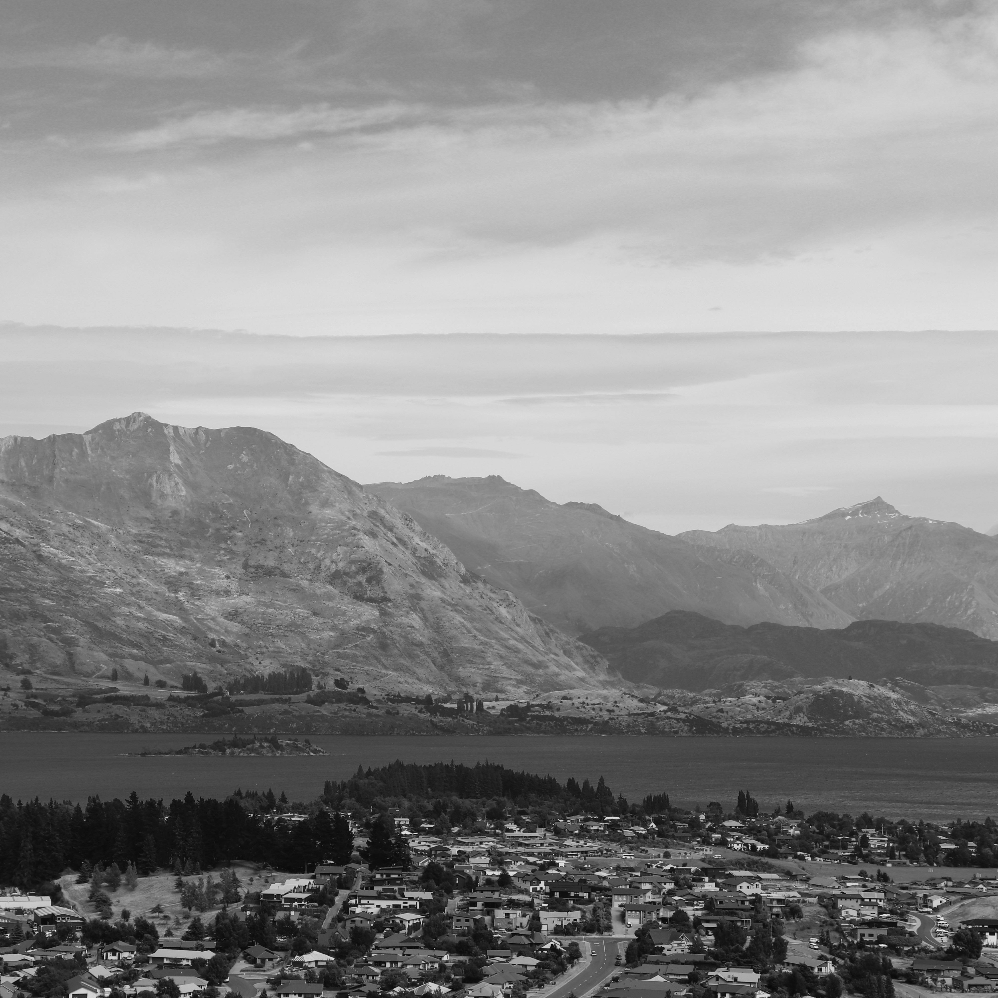 Quiet Basin Between Peaks: A Panoramic Village Flattened by Dusk
