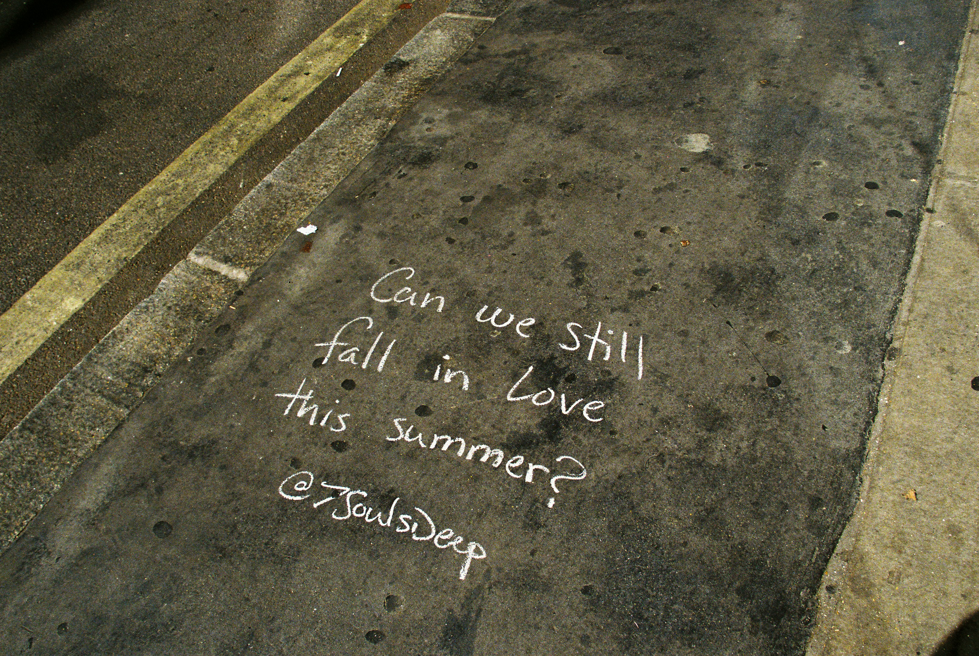 Chalked Question on a Rain-Slick Sidewalk Asking for Summer's Return