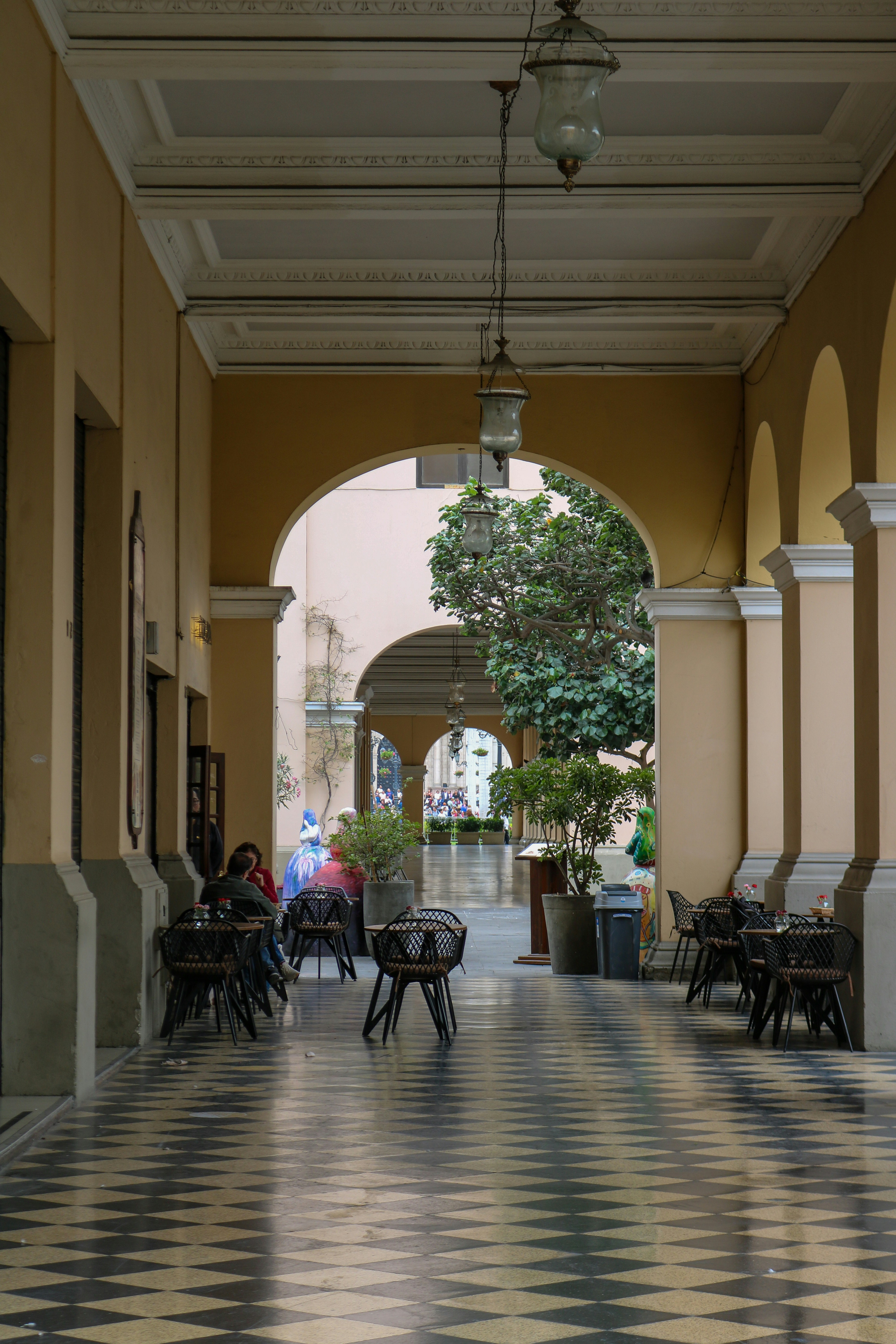 Arcade Corridor Cafe: Light, Shadows, and Tiles