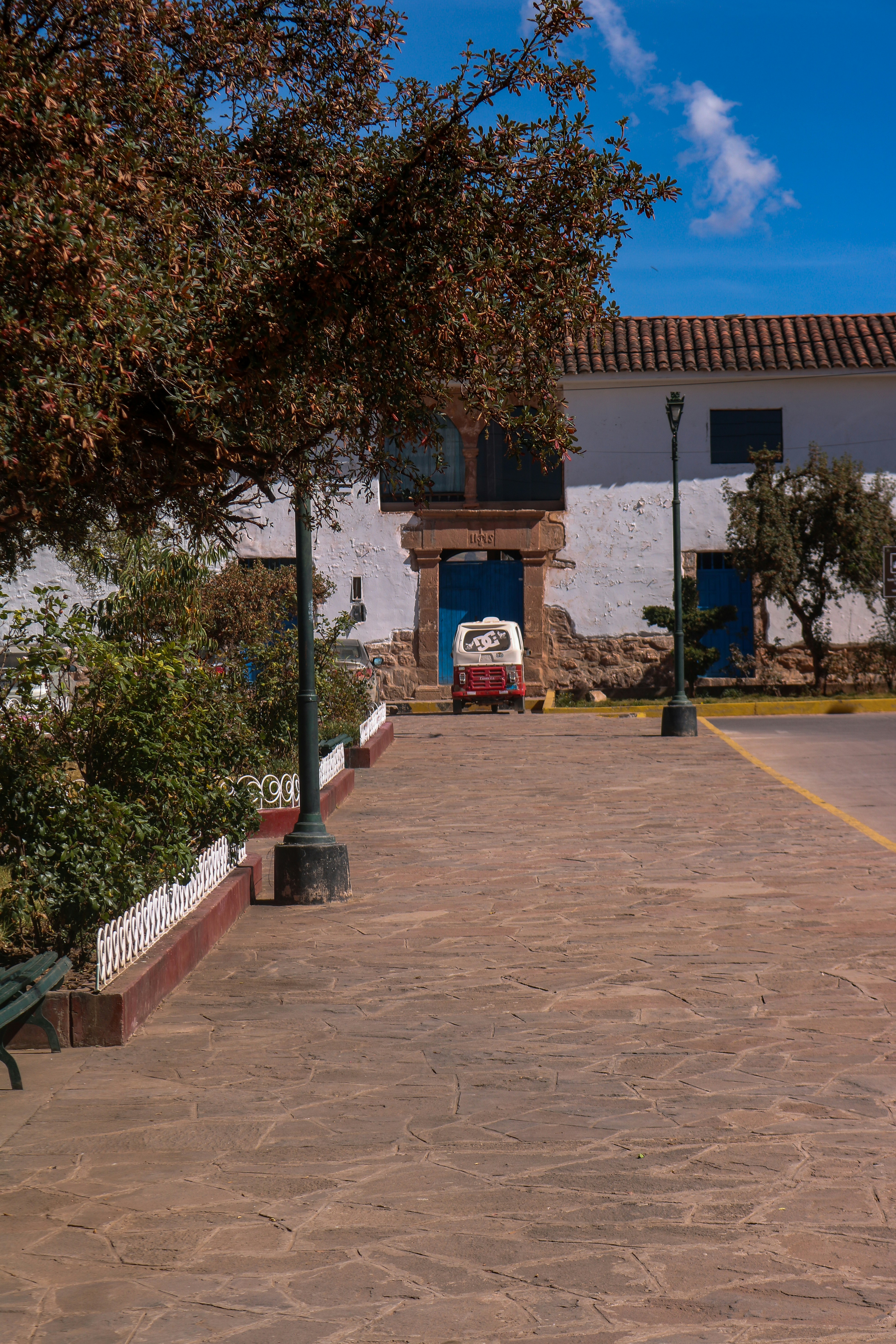 Colonial Plaza: A Narrow Street Leads to a White-Walled Gateway