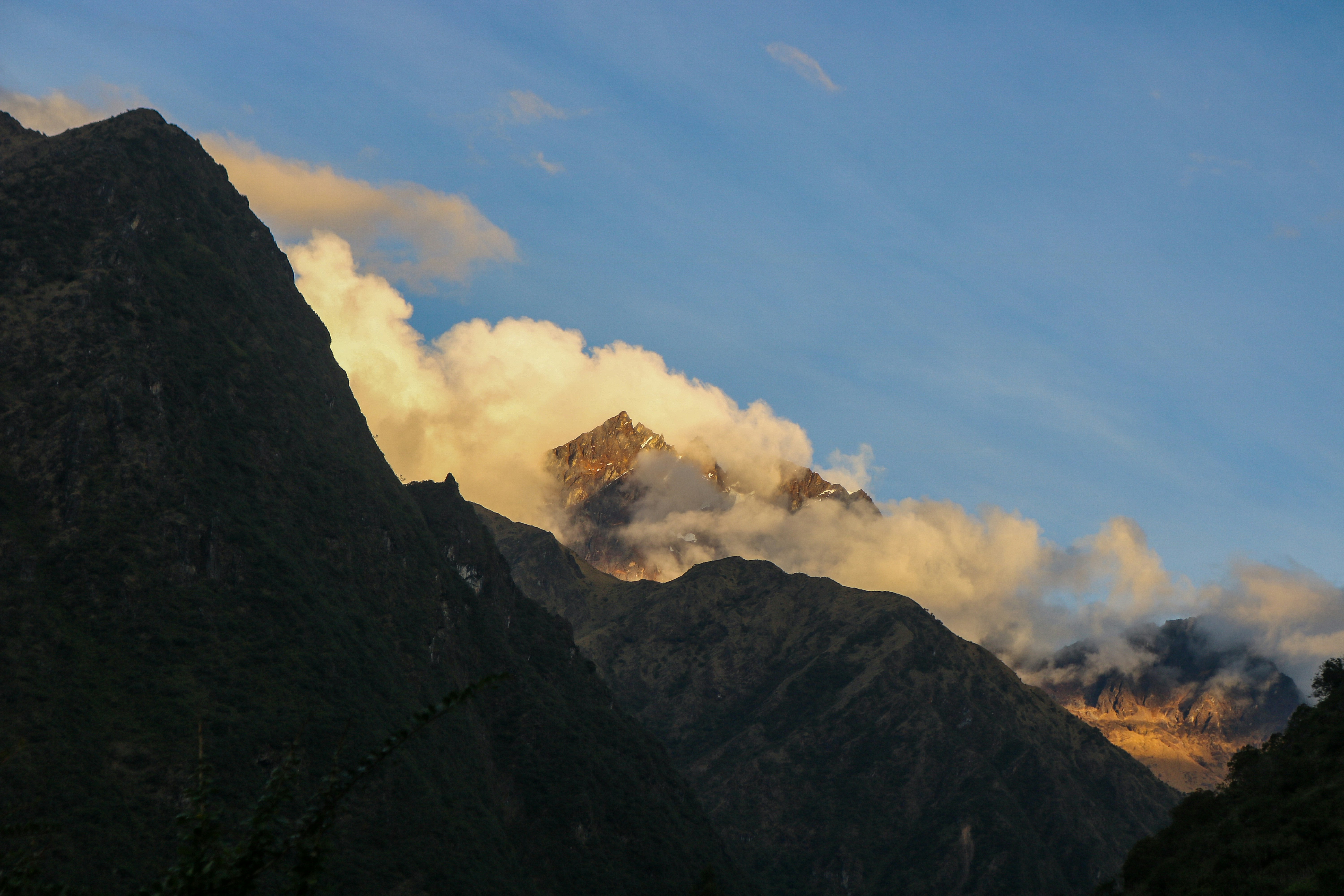 Sunlit Peak Breaks Through the Clouds over Silent Valleys