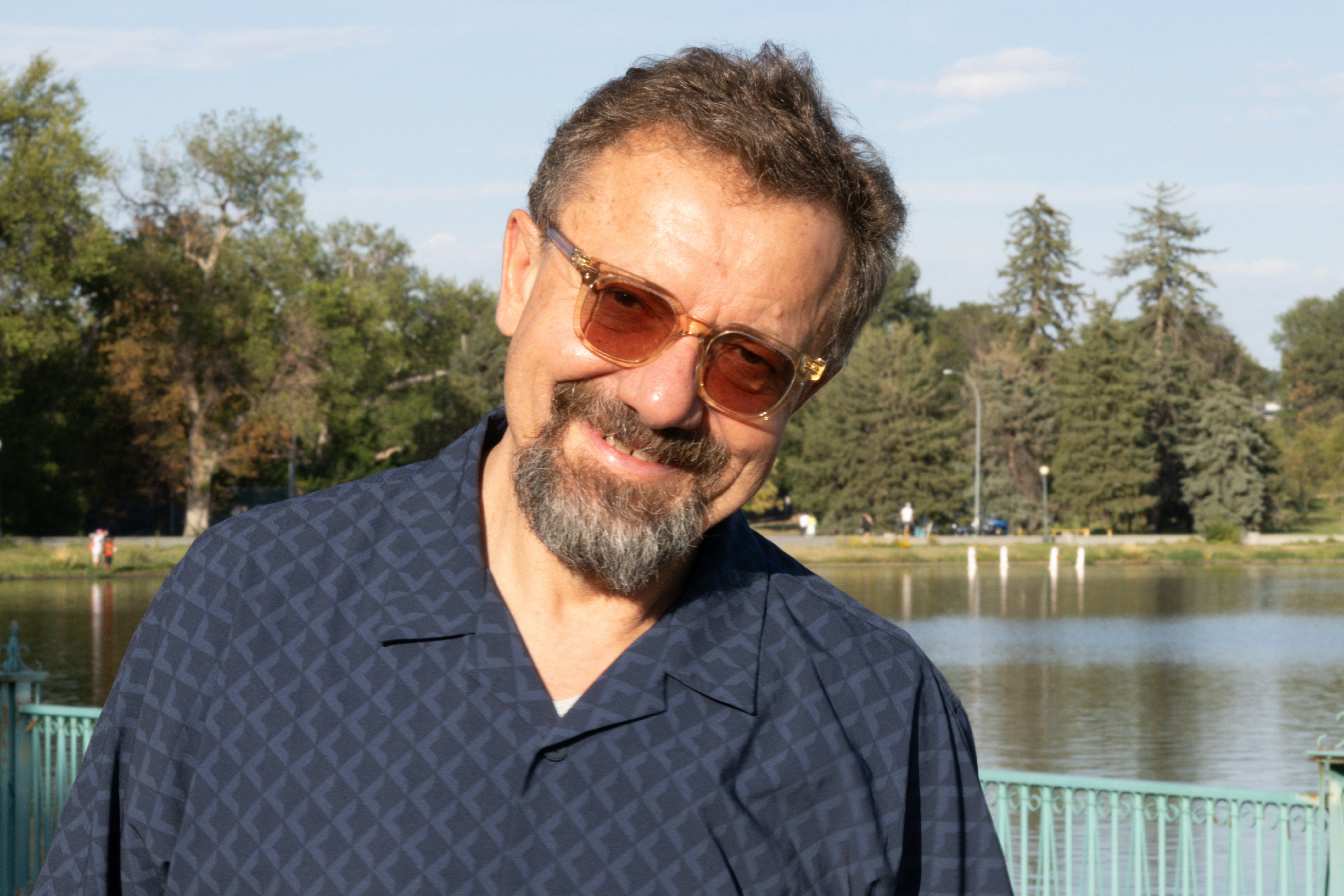 Smiling Portrait by the Water: Quiet Confidence in Sunlit Glass