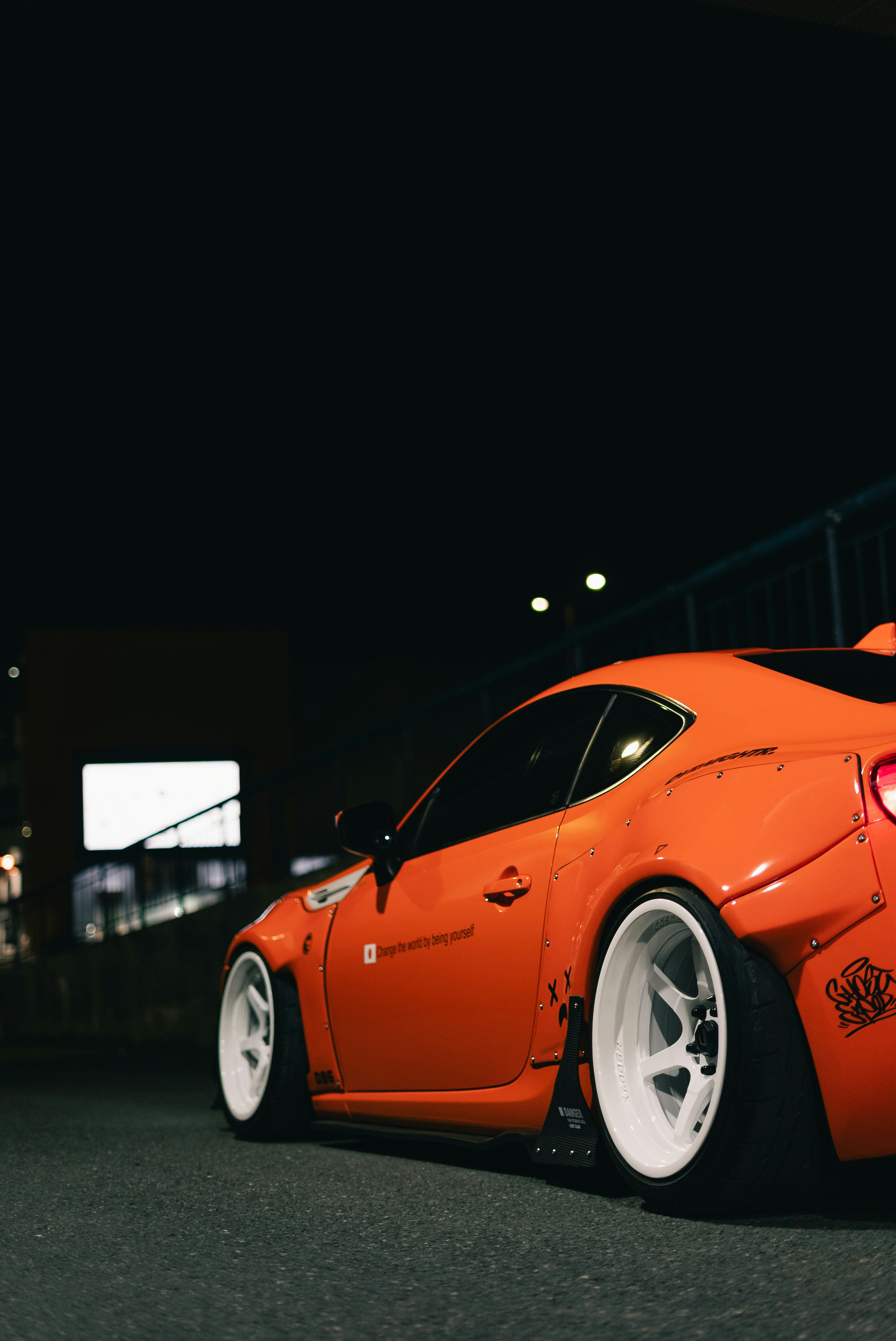 Orange Revolution: A Low-Slung Red racer under Nightlight