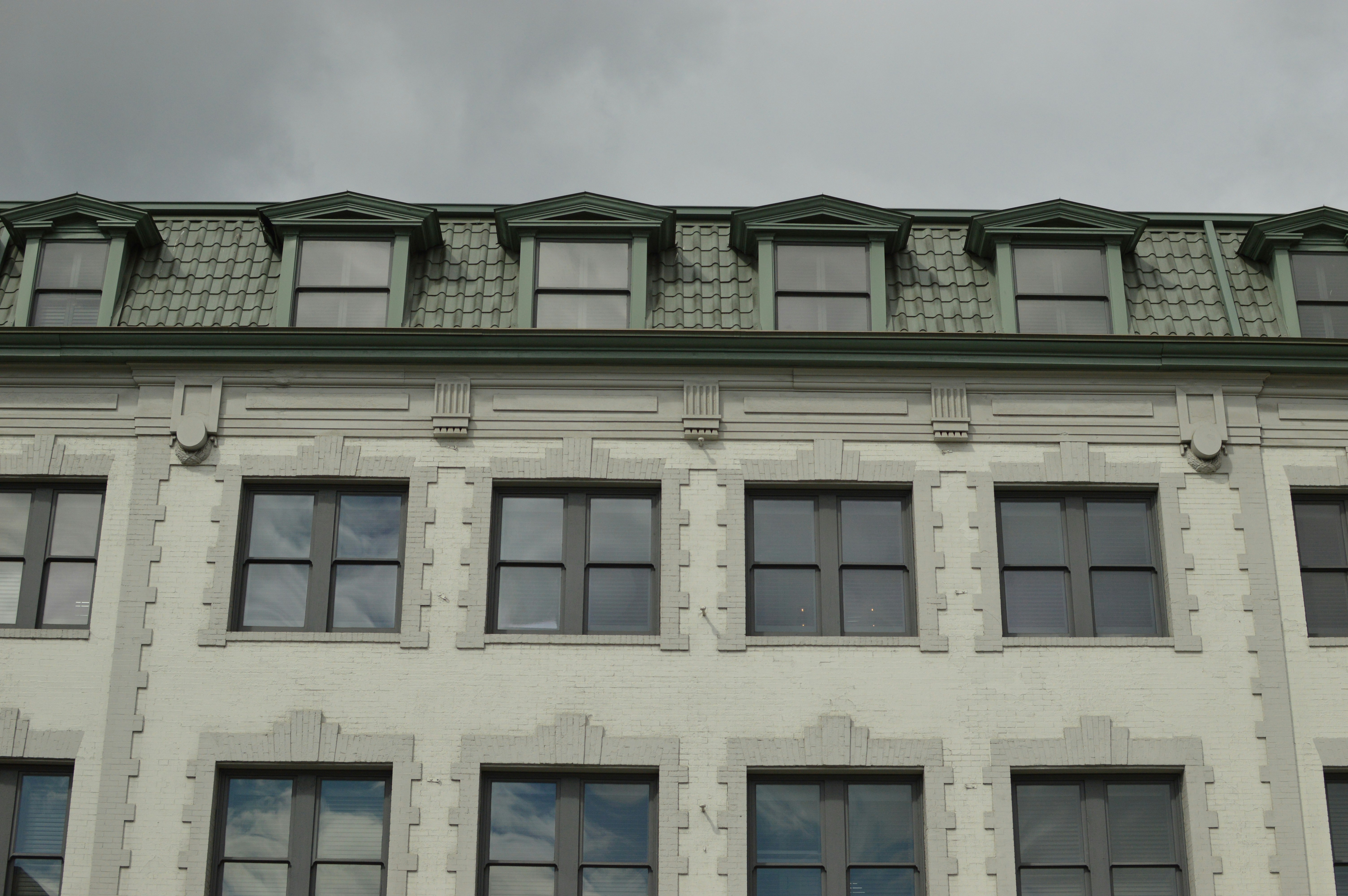 Dormer-Row Facade: A Quiet Symmetry of Windows and Stone