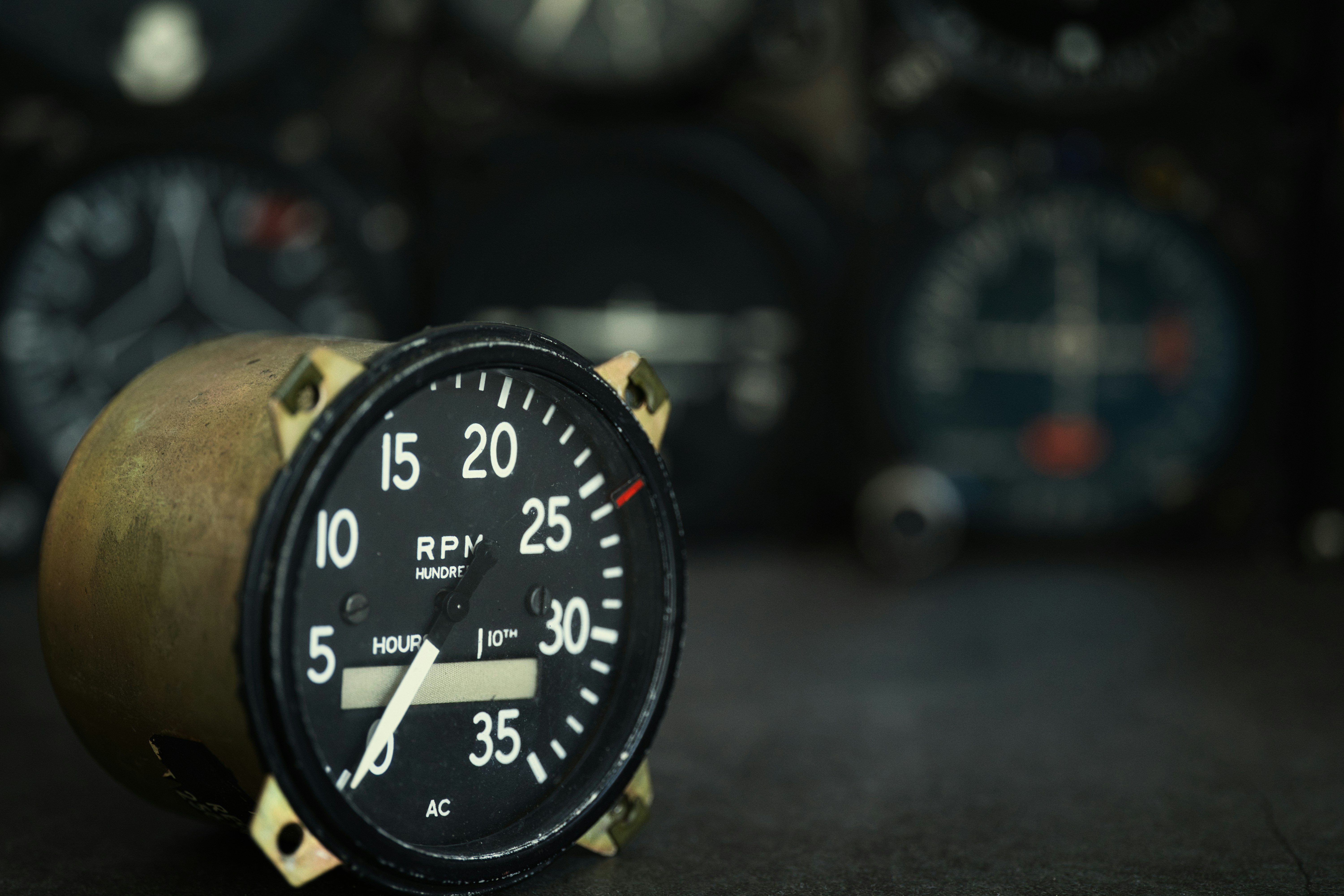 Rusty gauge in a dim cockpit: a forgotten relic
