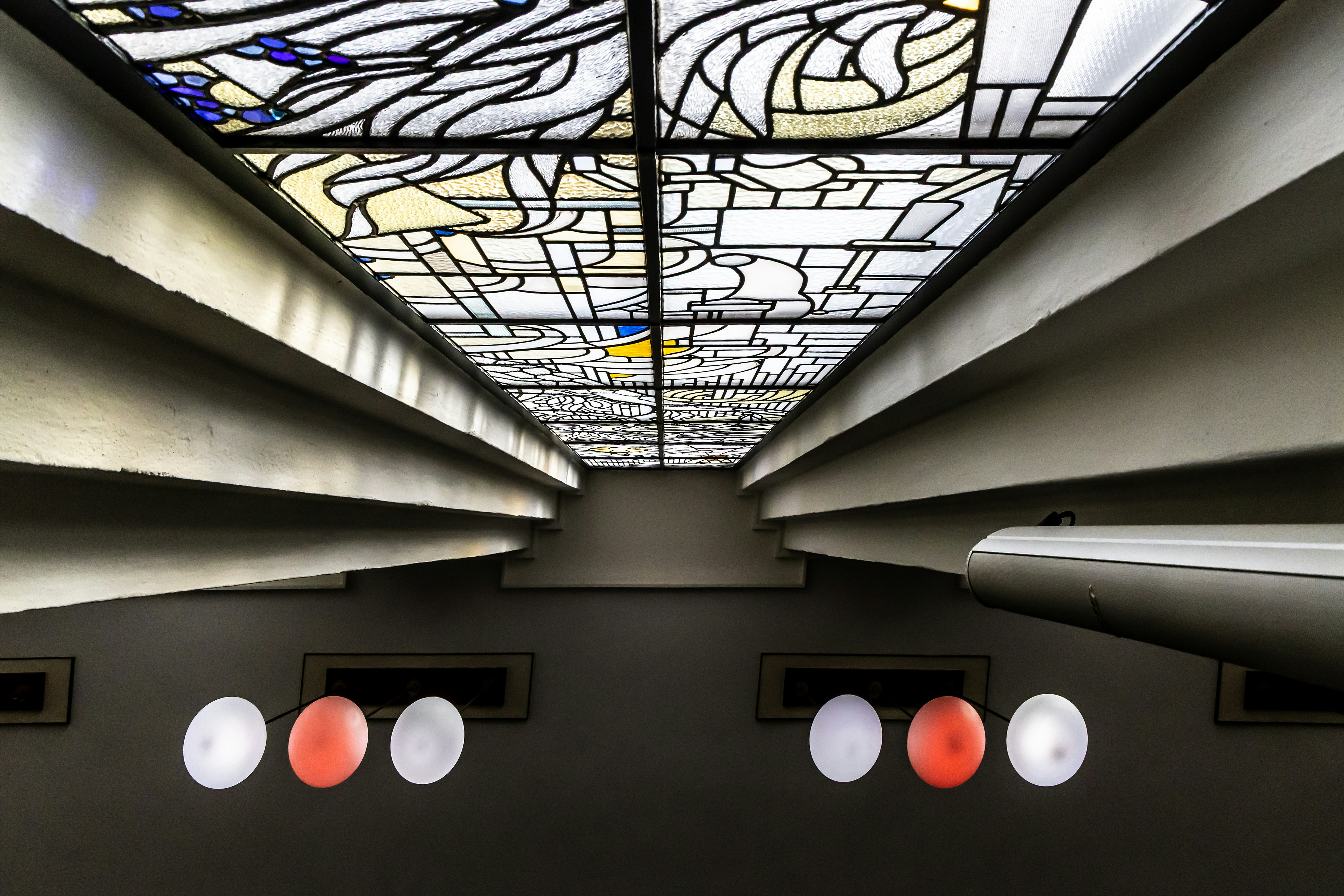 Stained Glass Canopy Over a Symmetrical Architecture Corridor