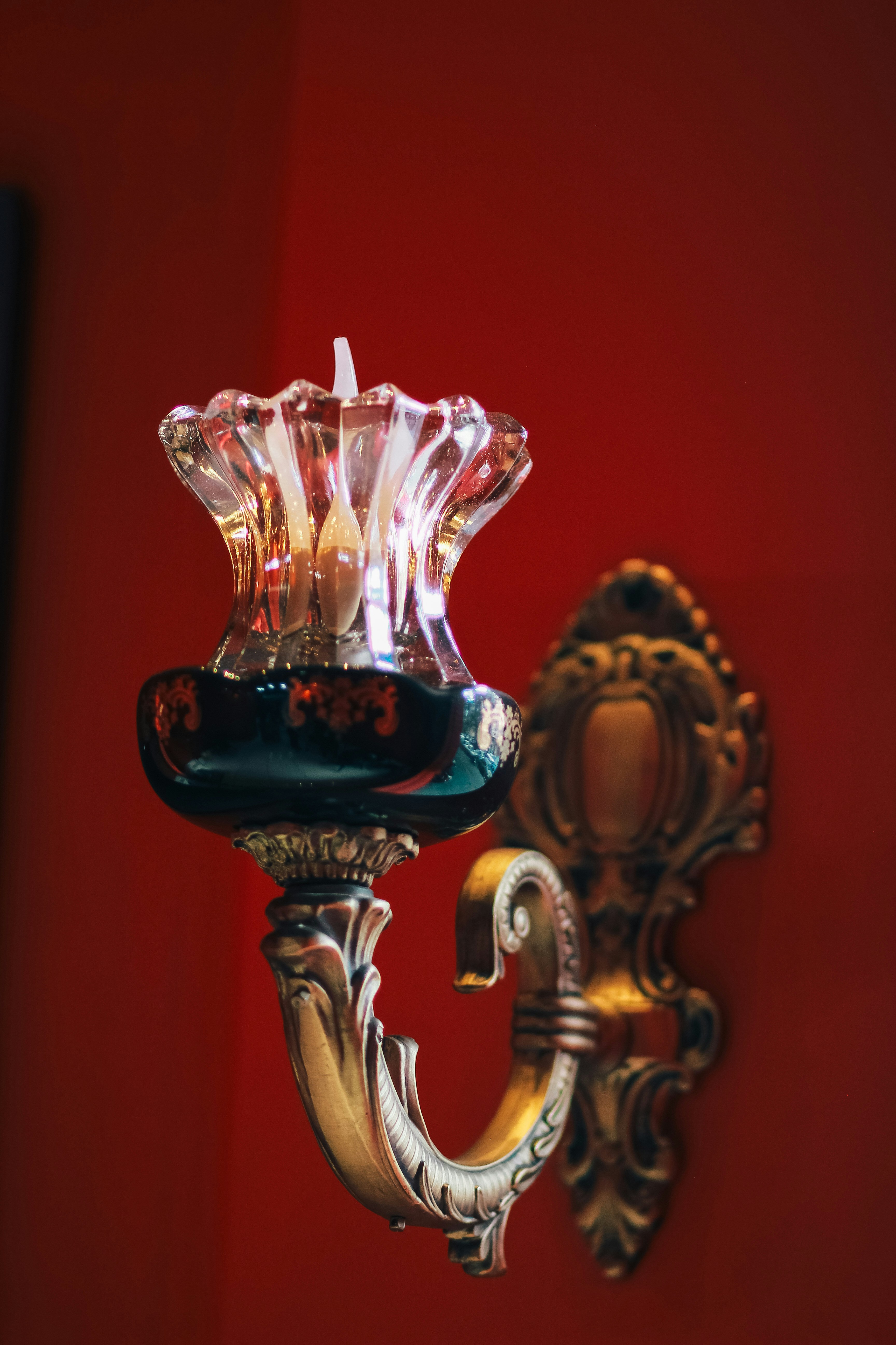 Crystal Lamp Sconce on a Rich Red Wall
