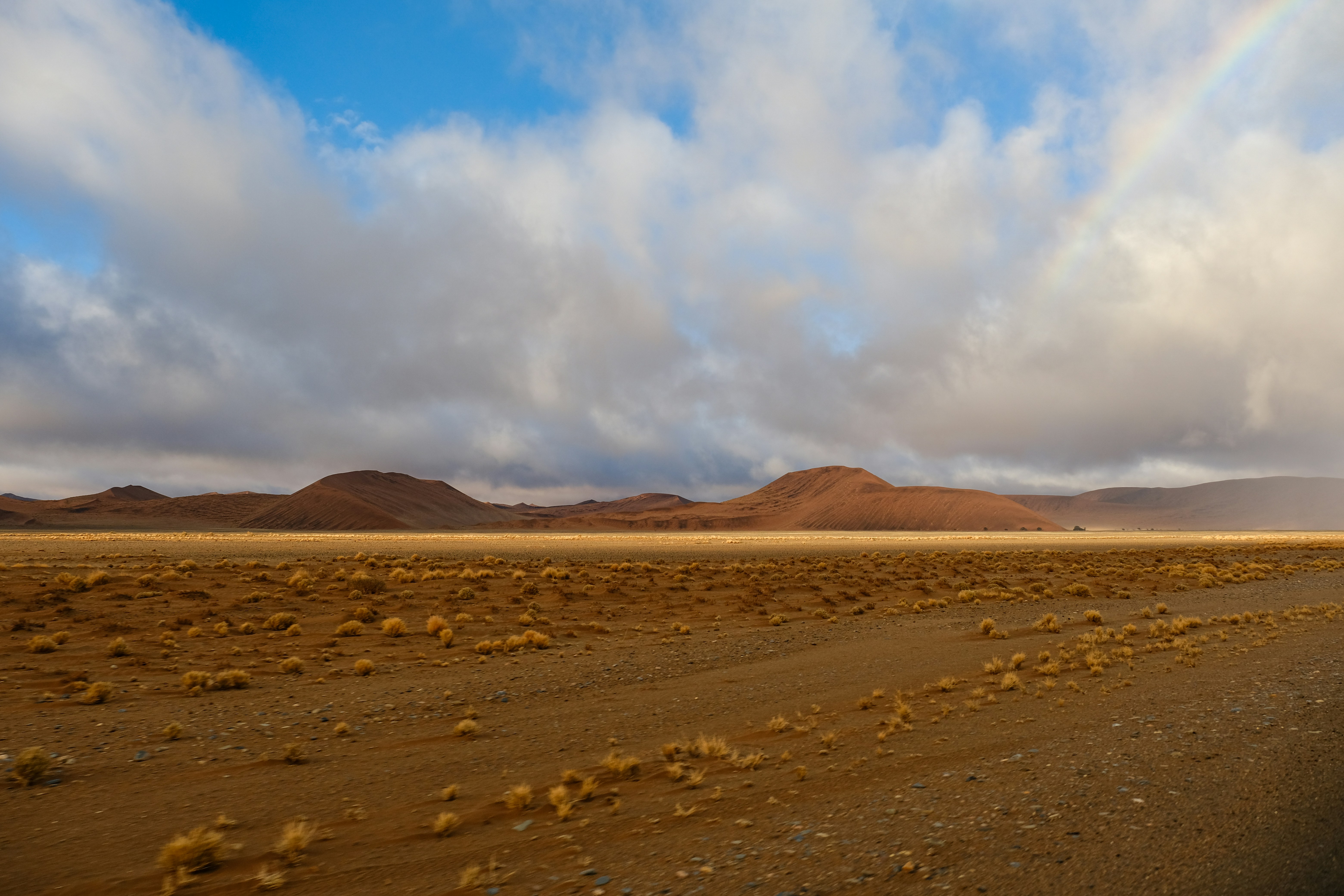Desert Dunes at Distant Ridgelines Under Soft Sky