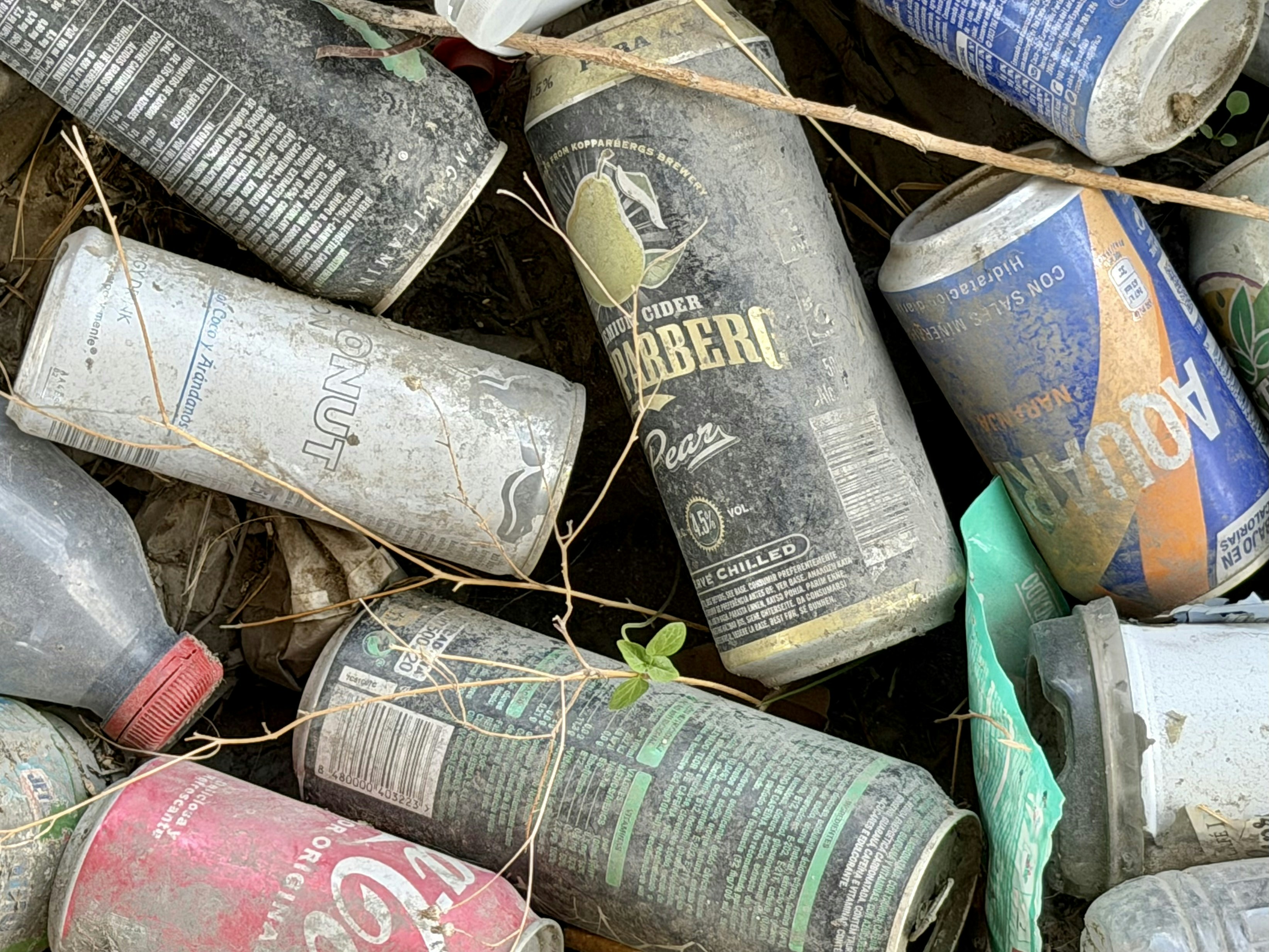 Derailed Memories: A Quiet Heap of Weathered Spray Cans