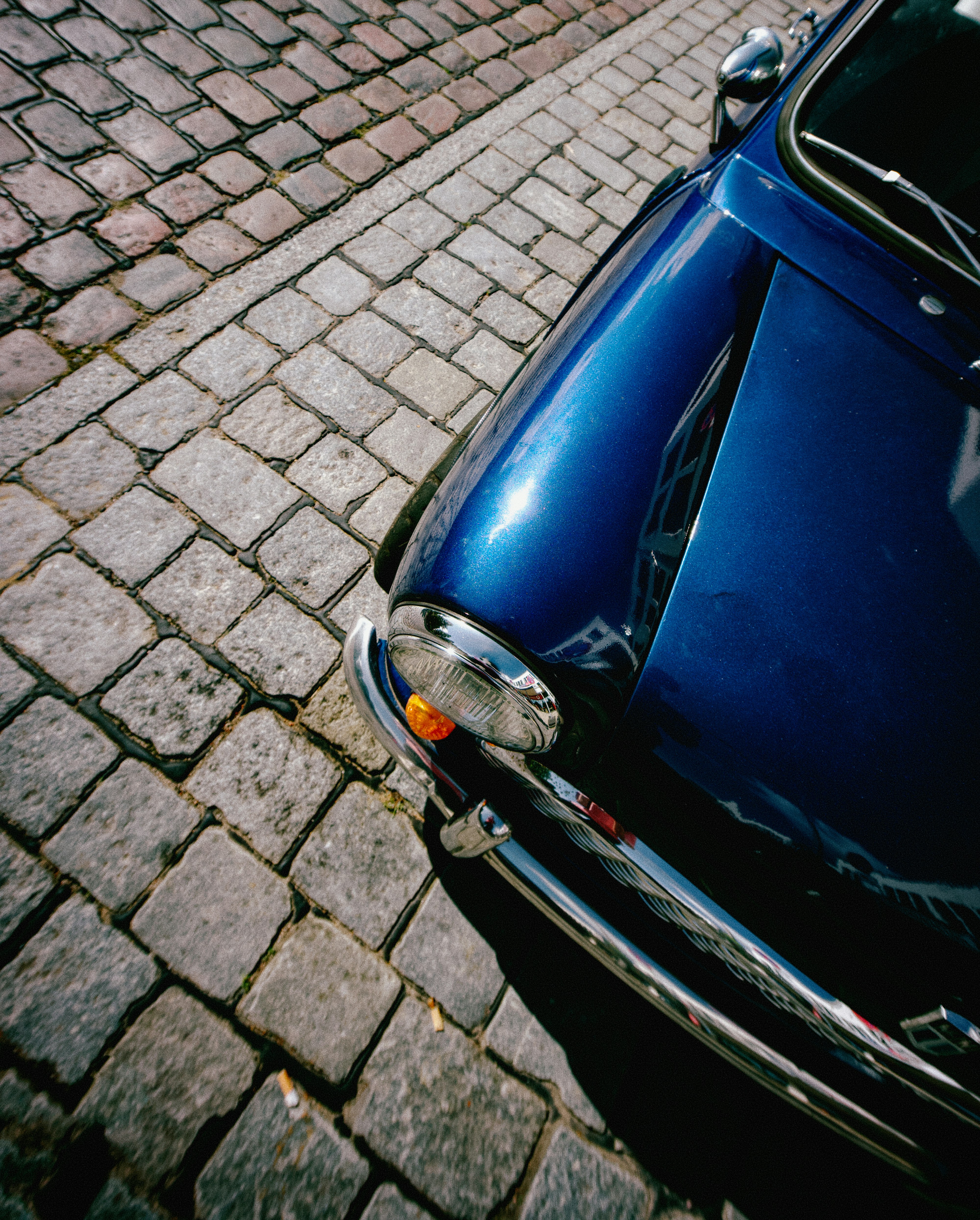 Blue Vintage Headlight and Cobblestone Curve