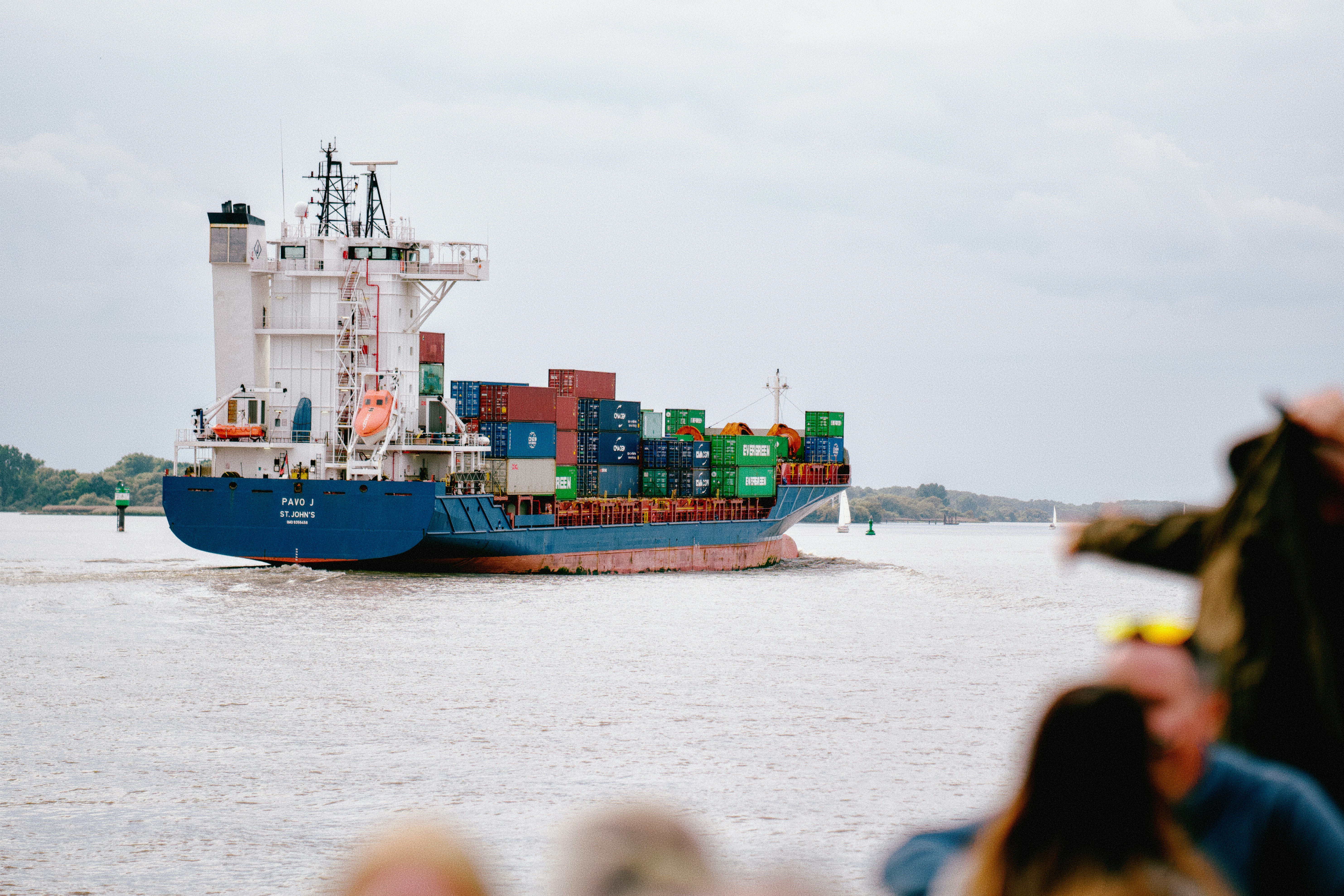 Harbor Giant: A Containership Slicing Through Calm Waters