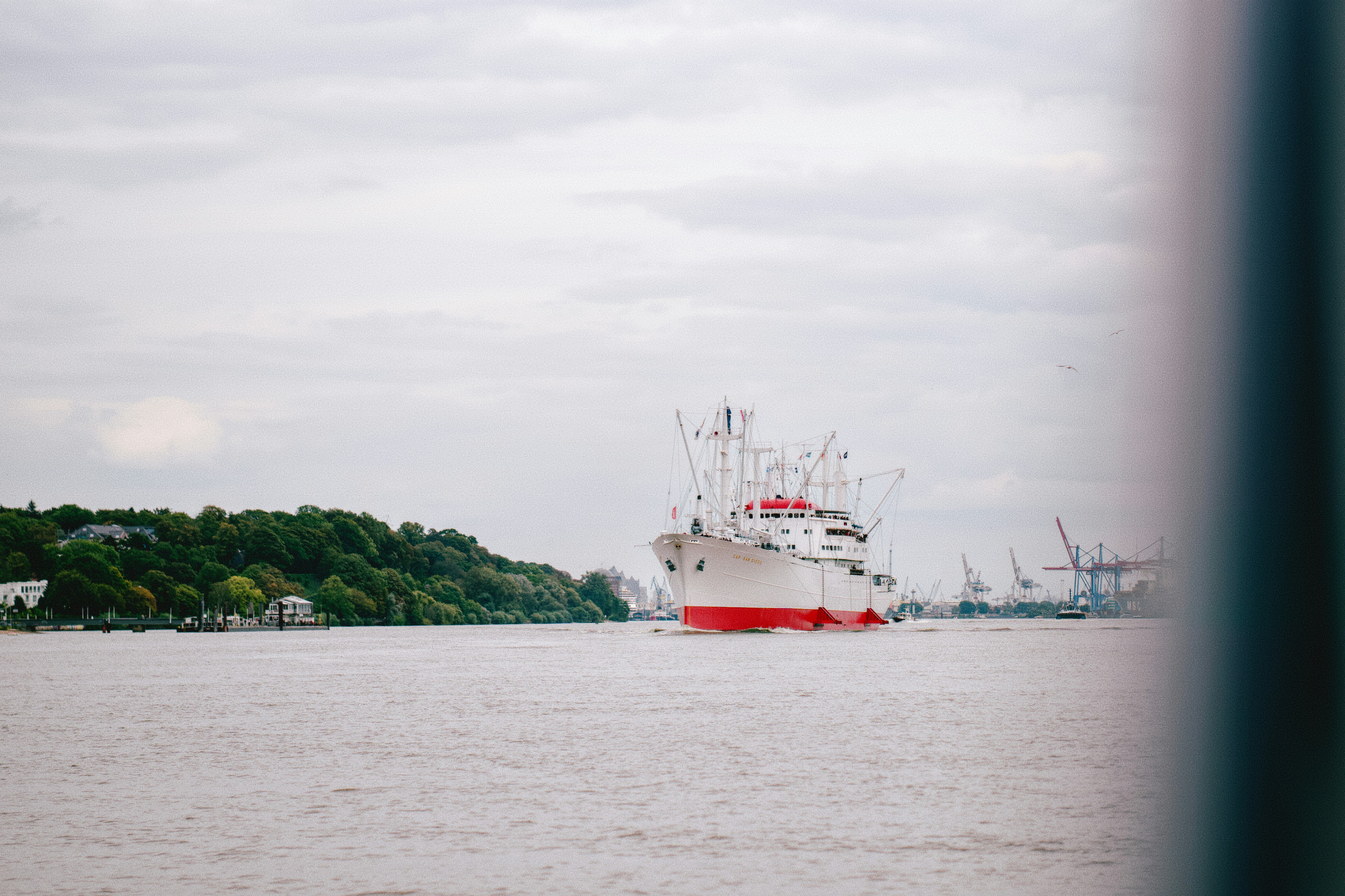 Red-hulled Contender Anchored Beyond the Docks