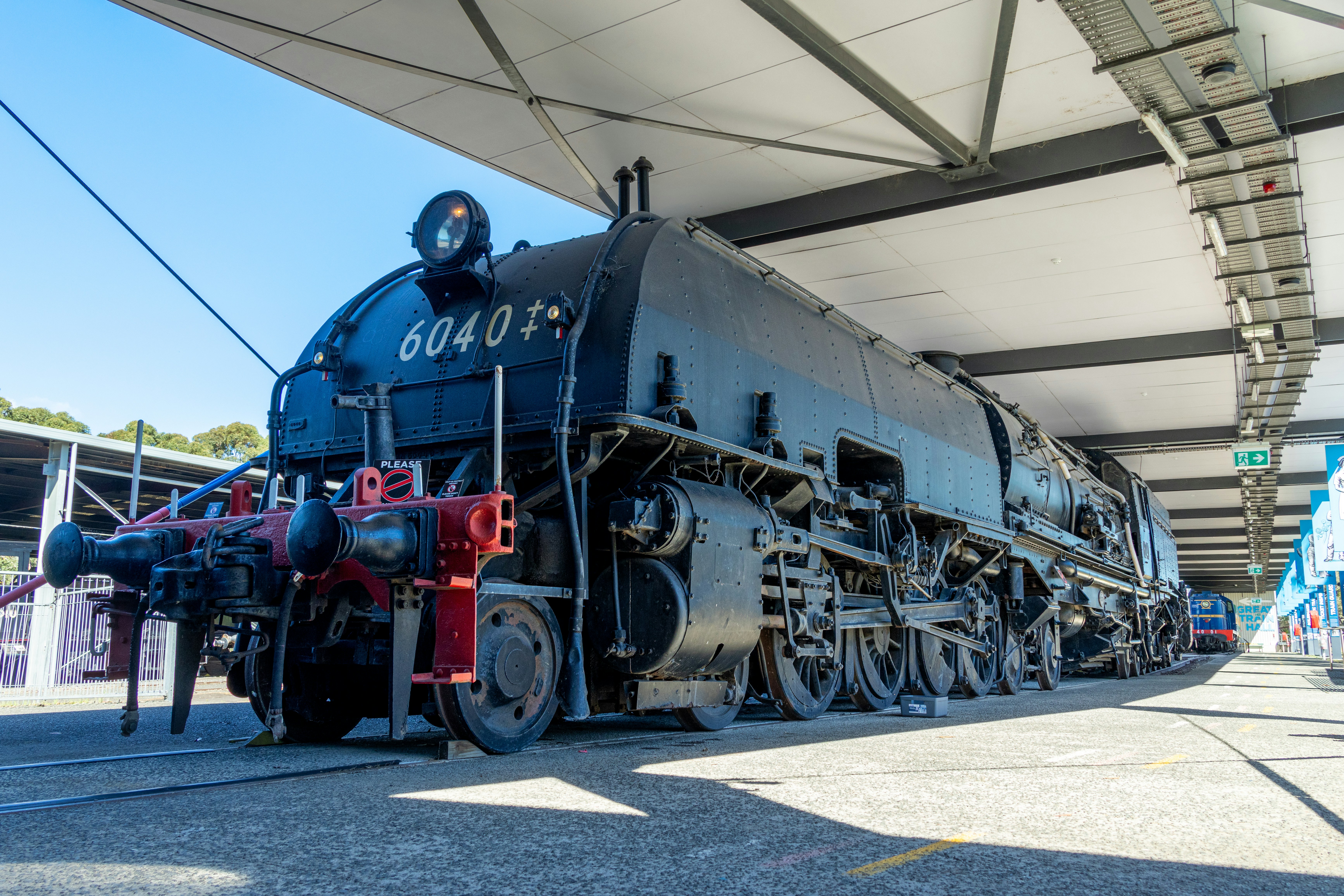 Steamwork at the Platform: A Stalwart Locomotive Lounging in Sunlit Silence