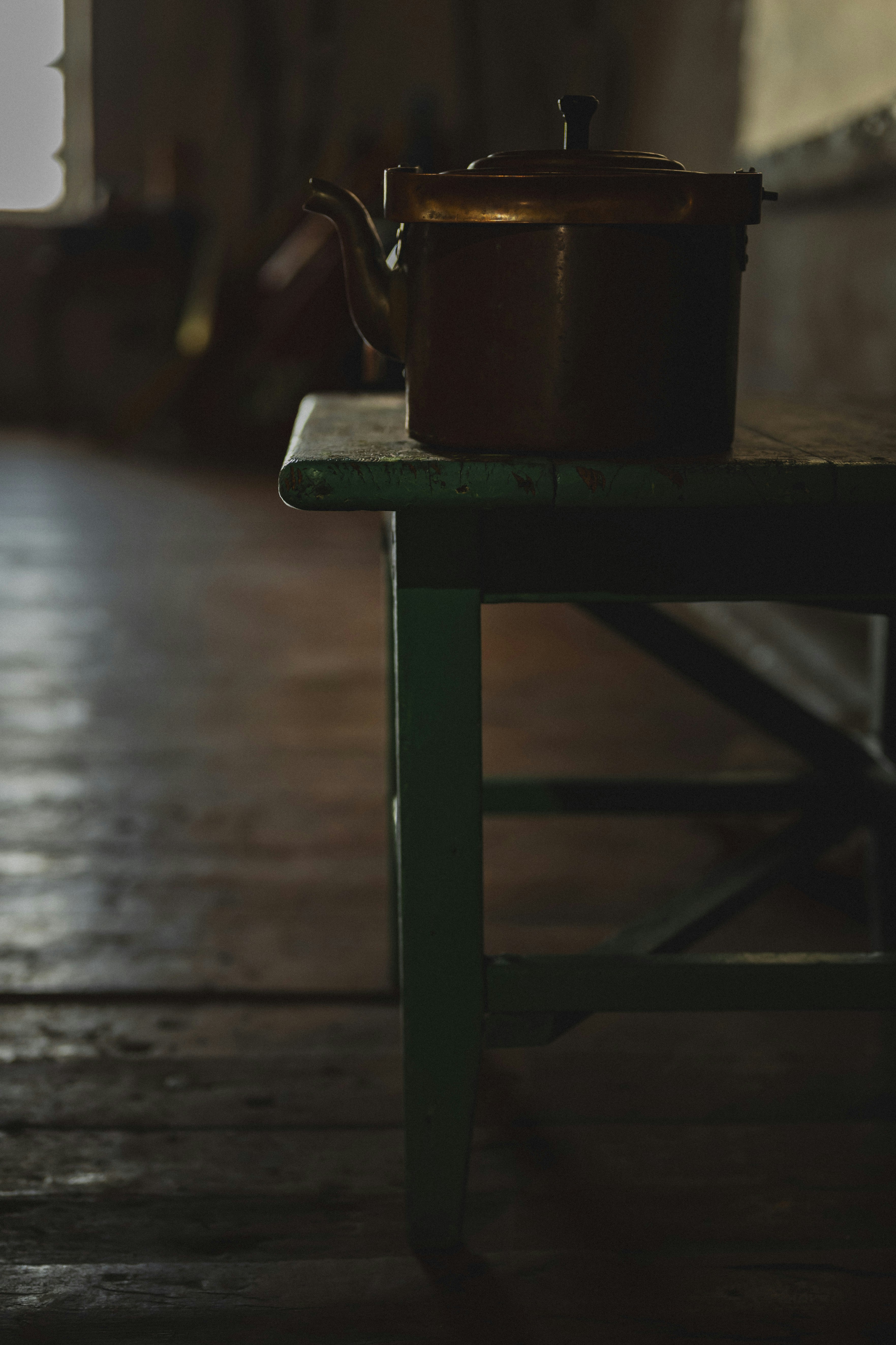 Quiet Boil: A Copper Kettle on a Weathered Green Table
