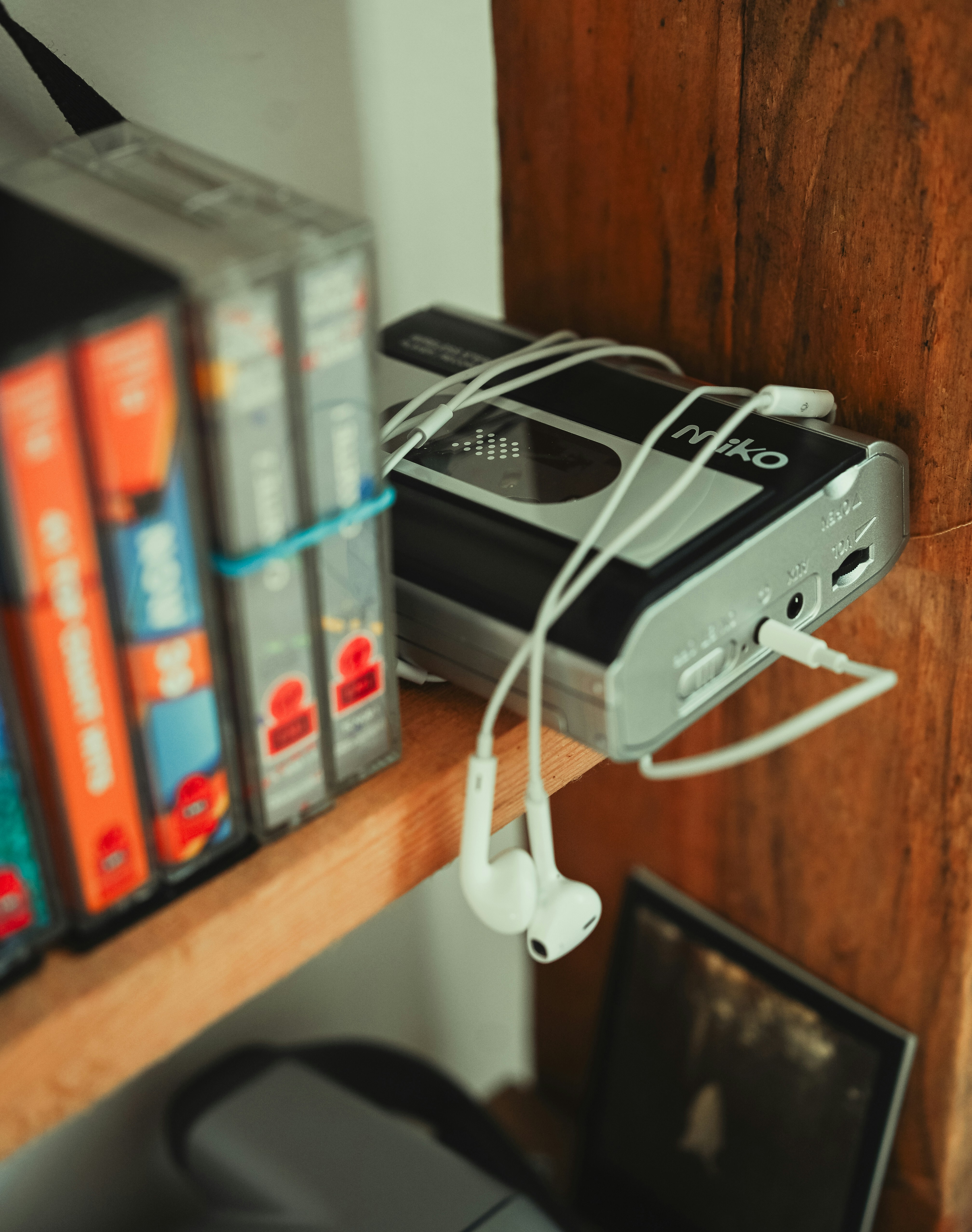 Urban Shelfscape: A Collage of Cords, Earbuds, and Retro Tech
