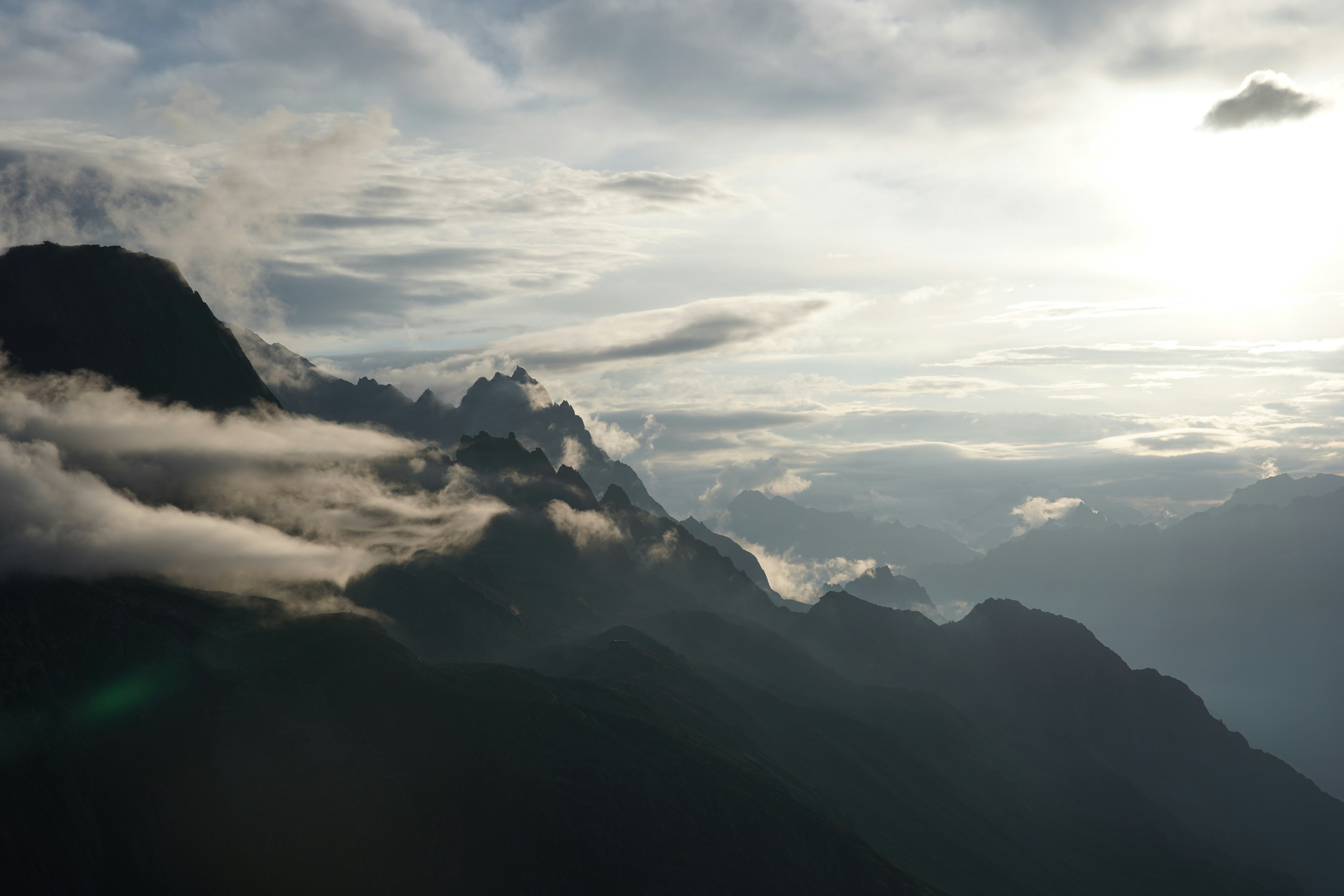 Glacial Ridge in Mist: Sunlit Peaks Above a Sea of Clouds