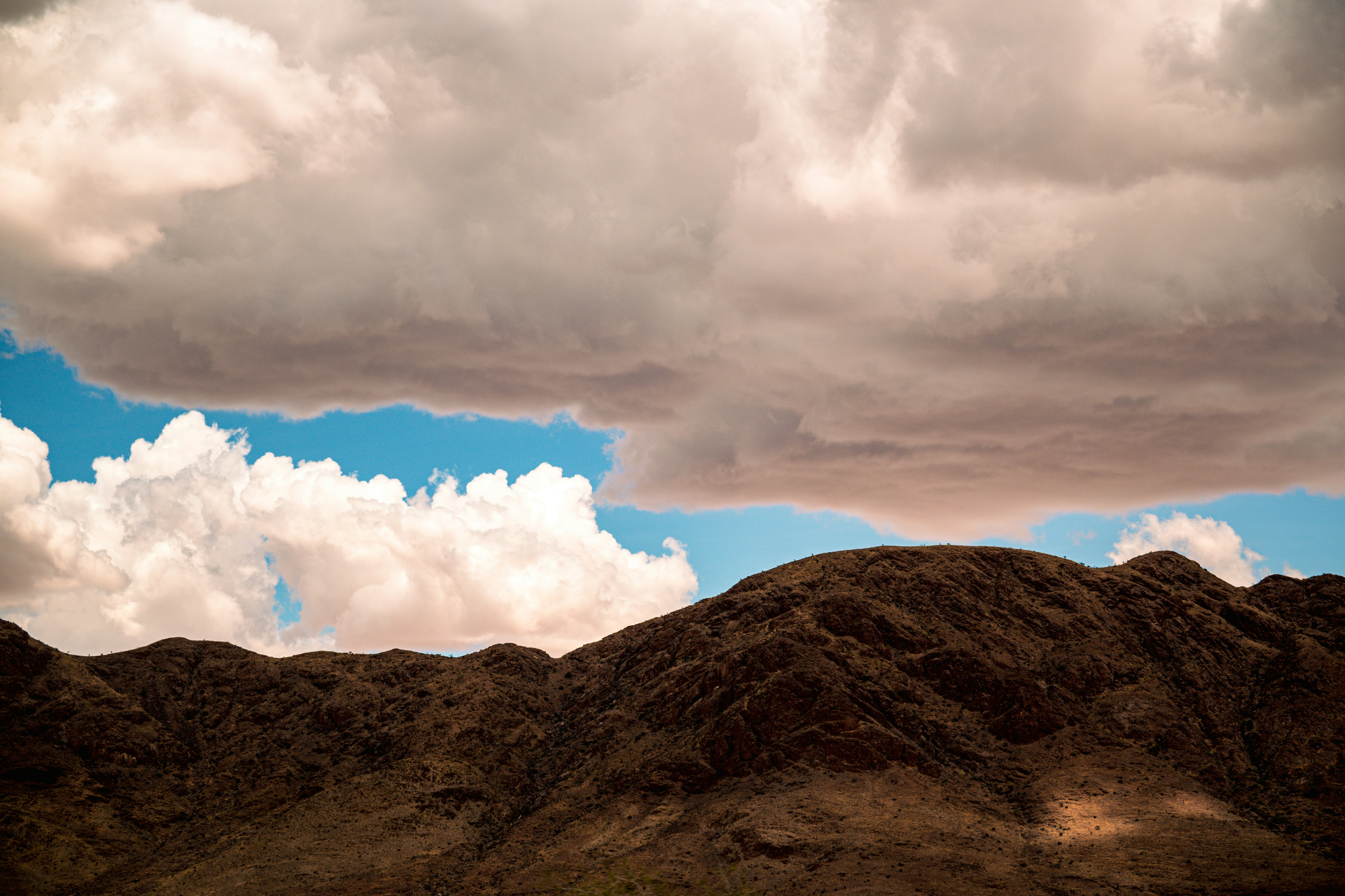 Low Sunlit Ridge Under Expanding Cumulus