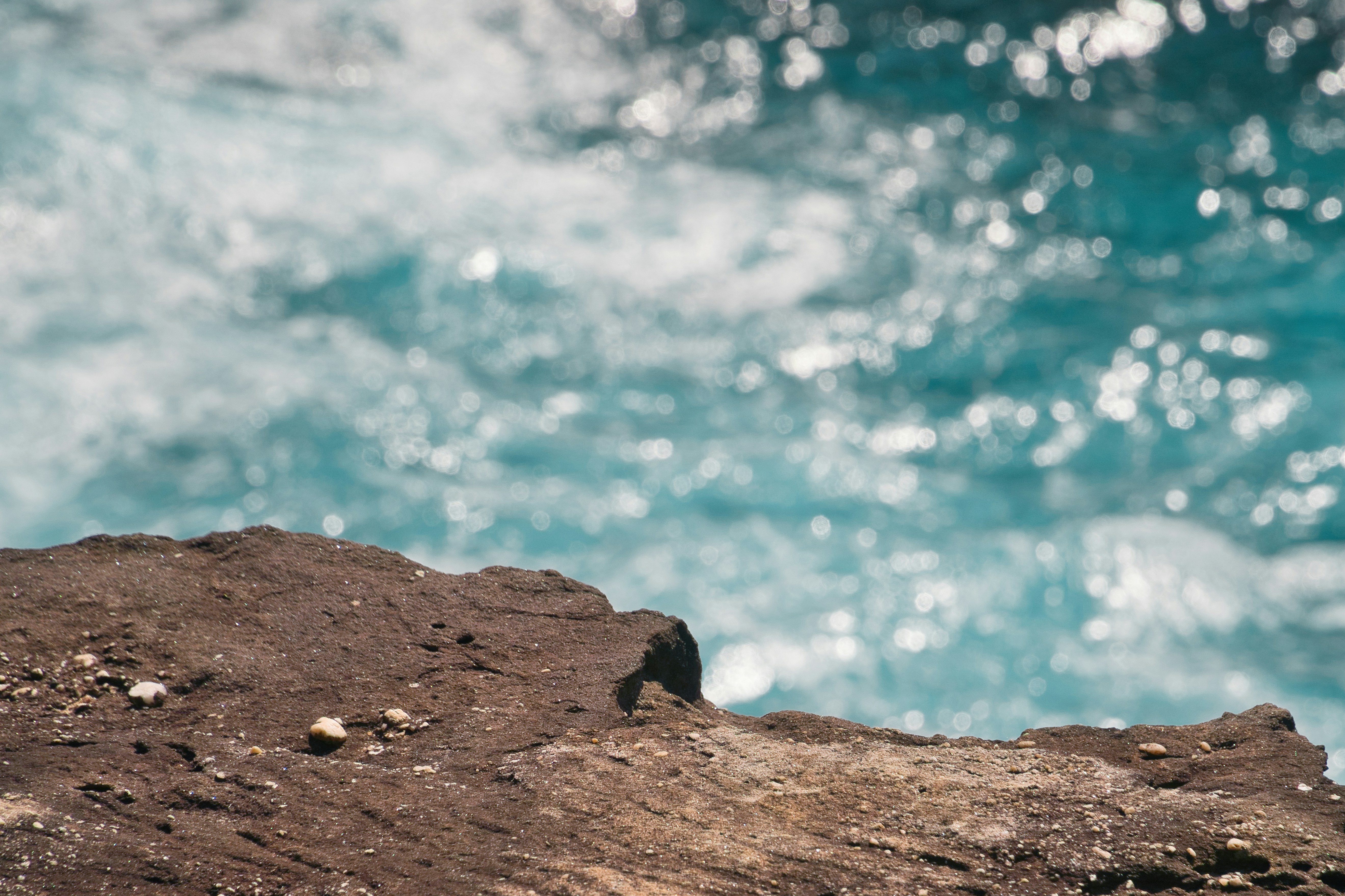 Rugged shoreline edge meeting turquoise surf