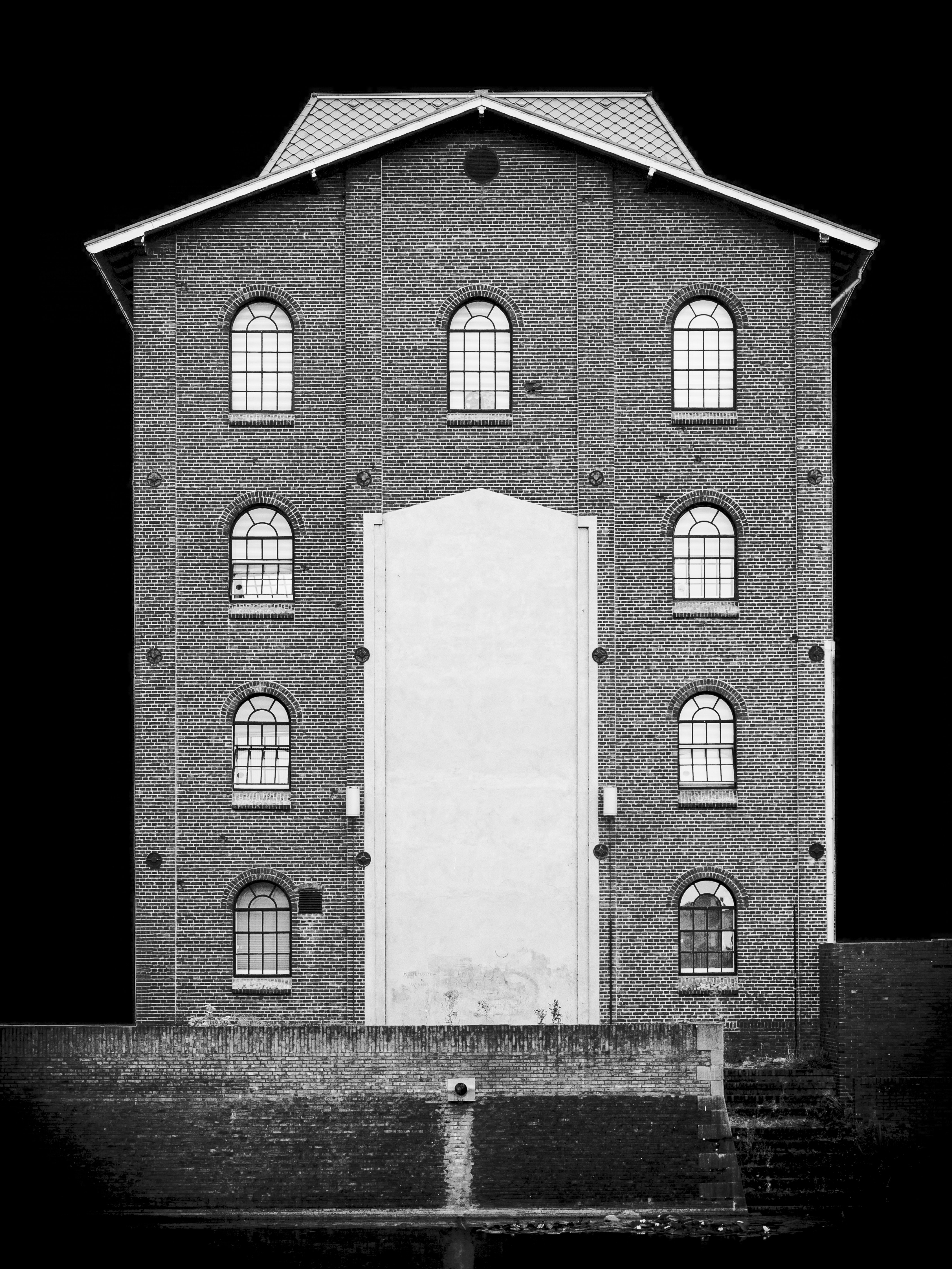 Industrial Monument: A Brick Facade Rising from the River’s Edge
