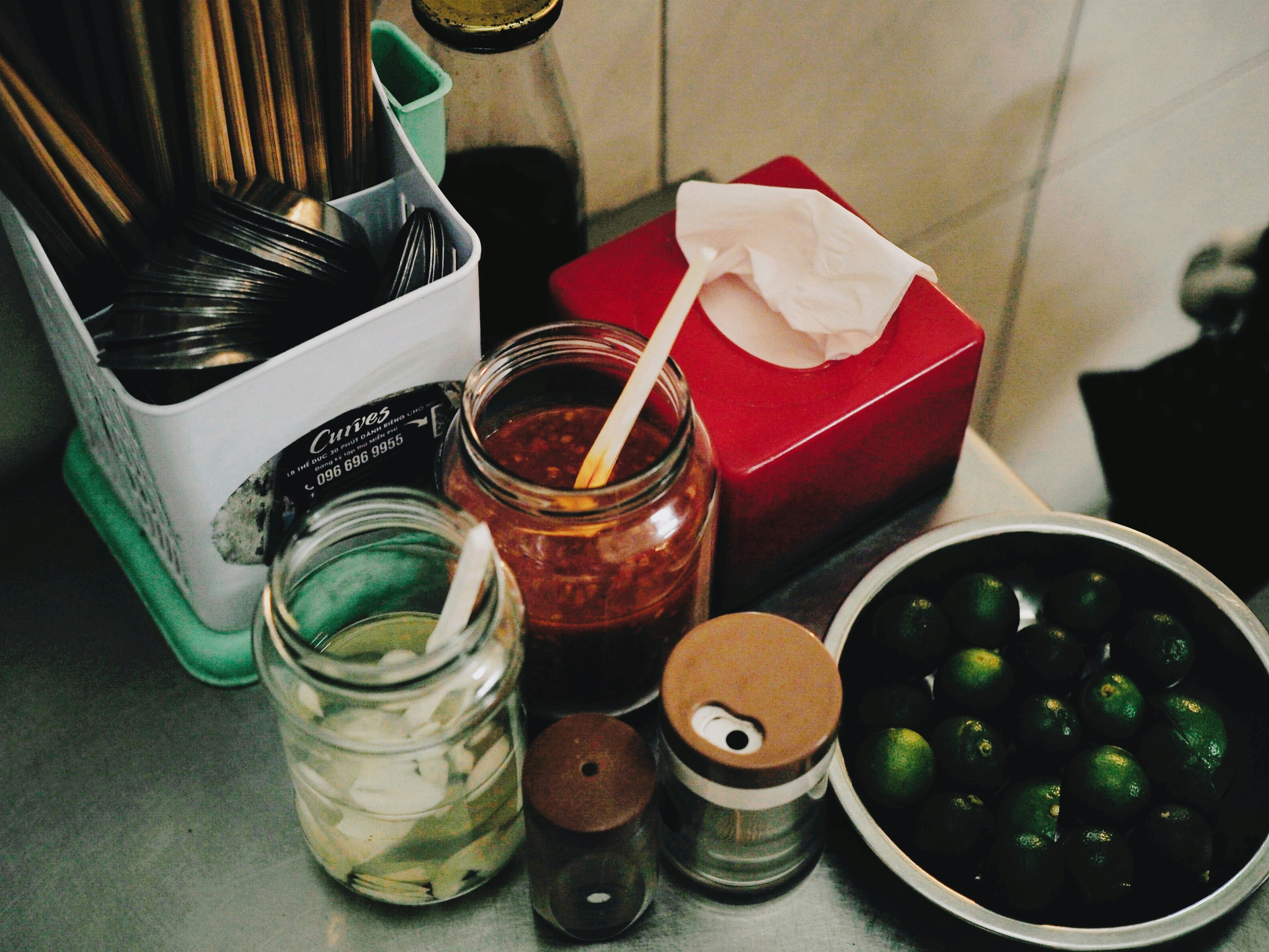 Lidless Pantry: A Quiet Array of Jars and Citrus on a Kitchen Counter