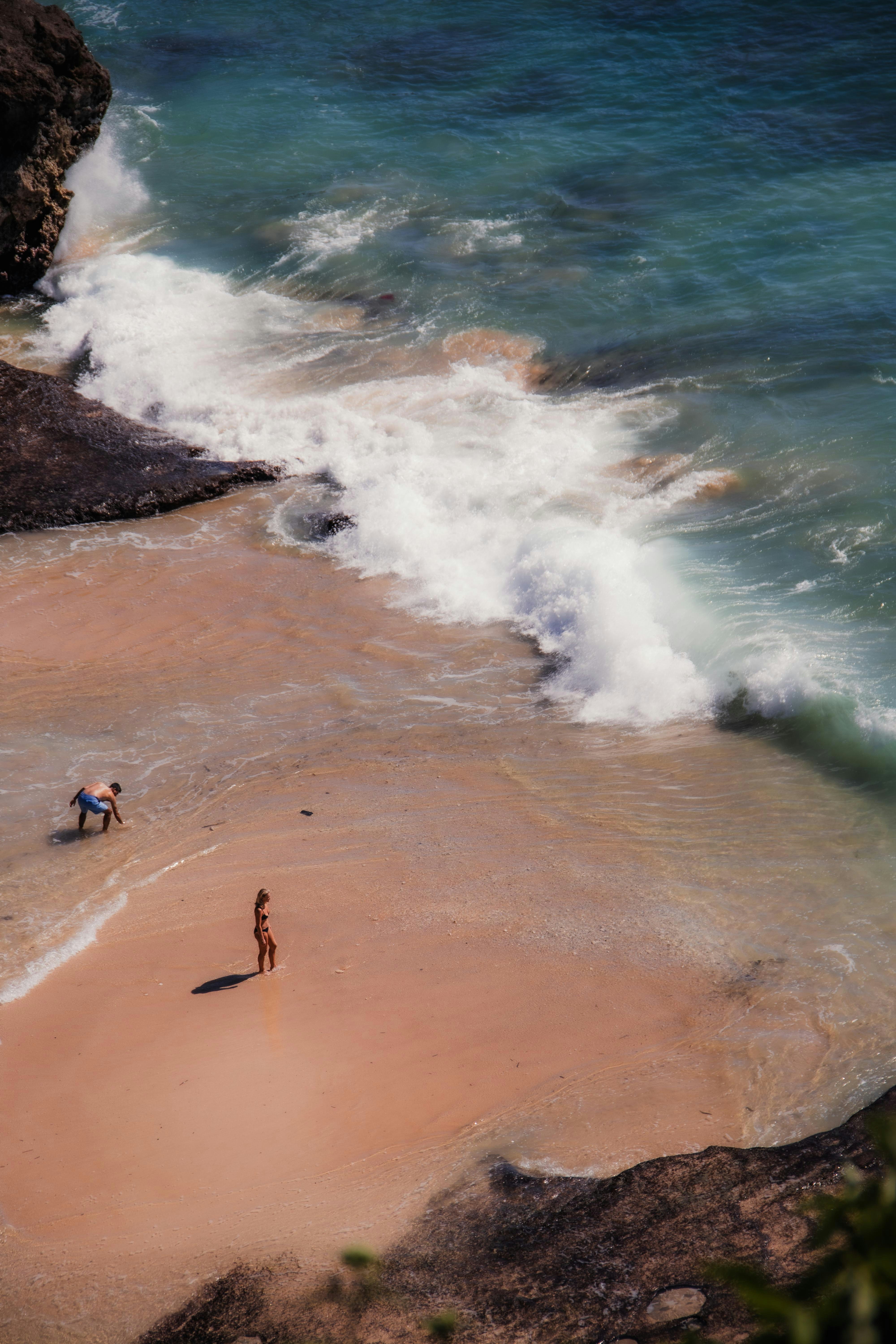 Solitary Runner on a Quiet Shore Beneath Crashing Blues