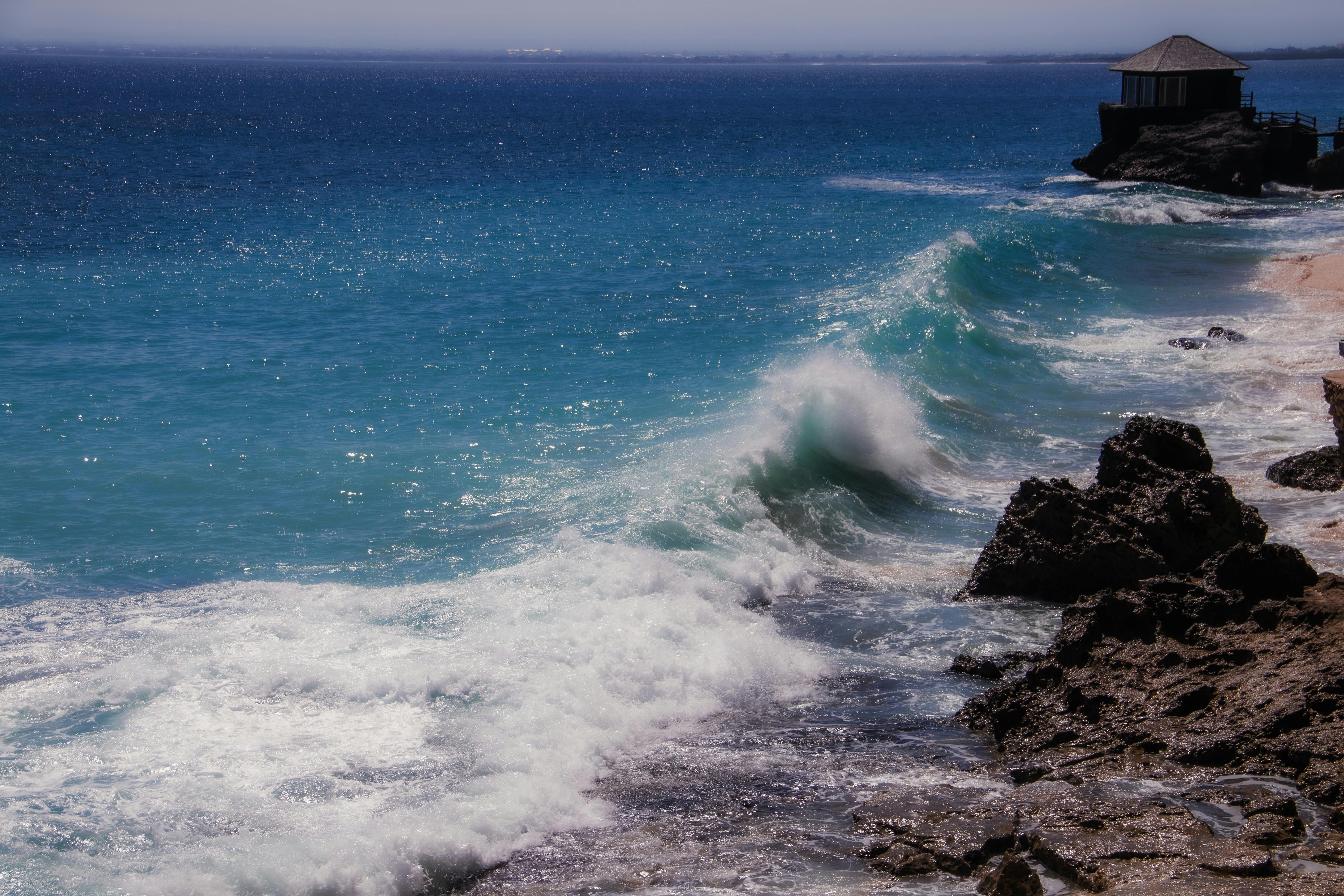 Azure Crest: Waves Breaking Against the Rocky Promenade