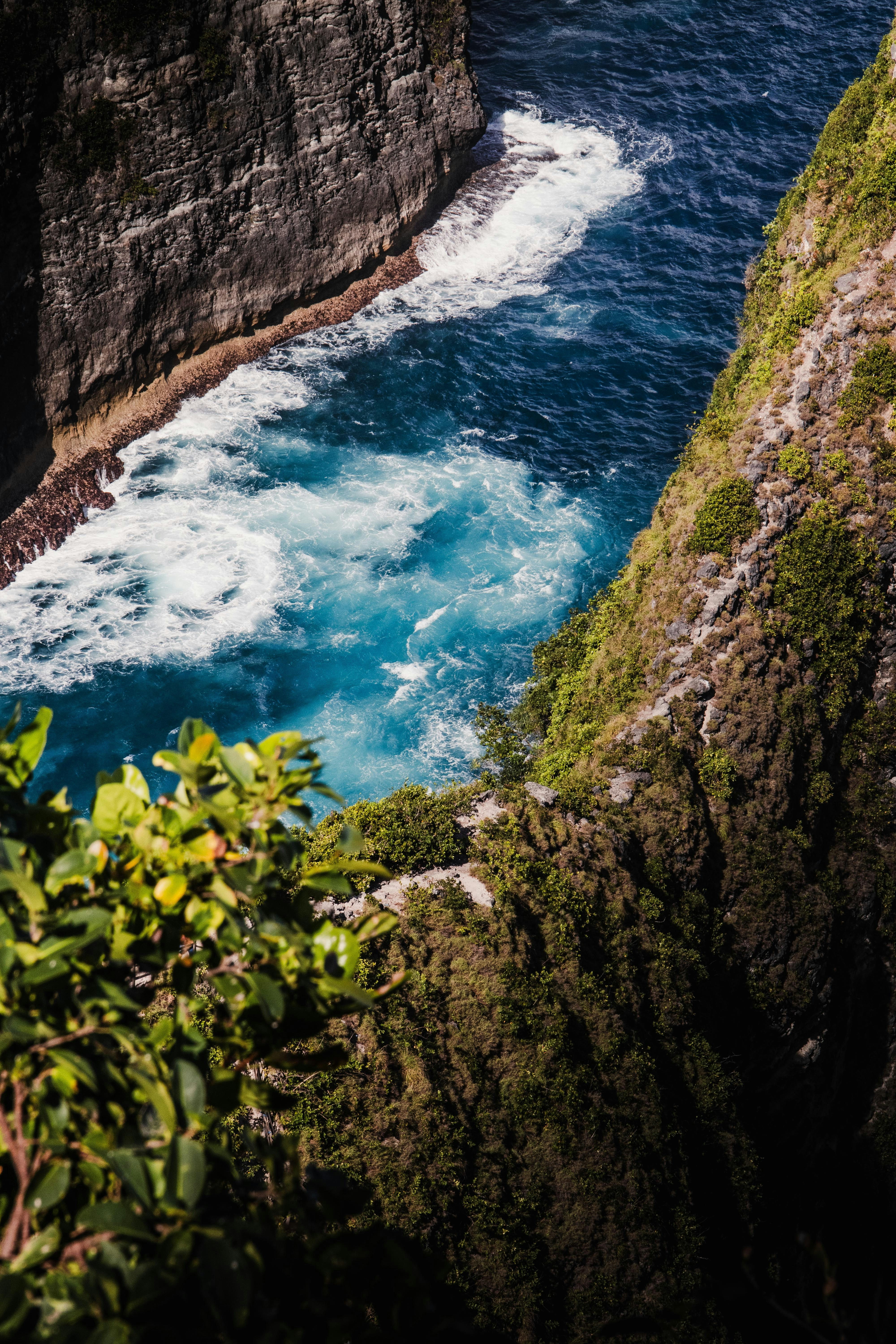 Cliffside Crest: Turquoise Sea Between Green Cliffs