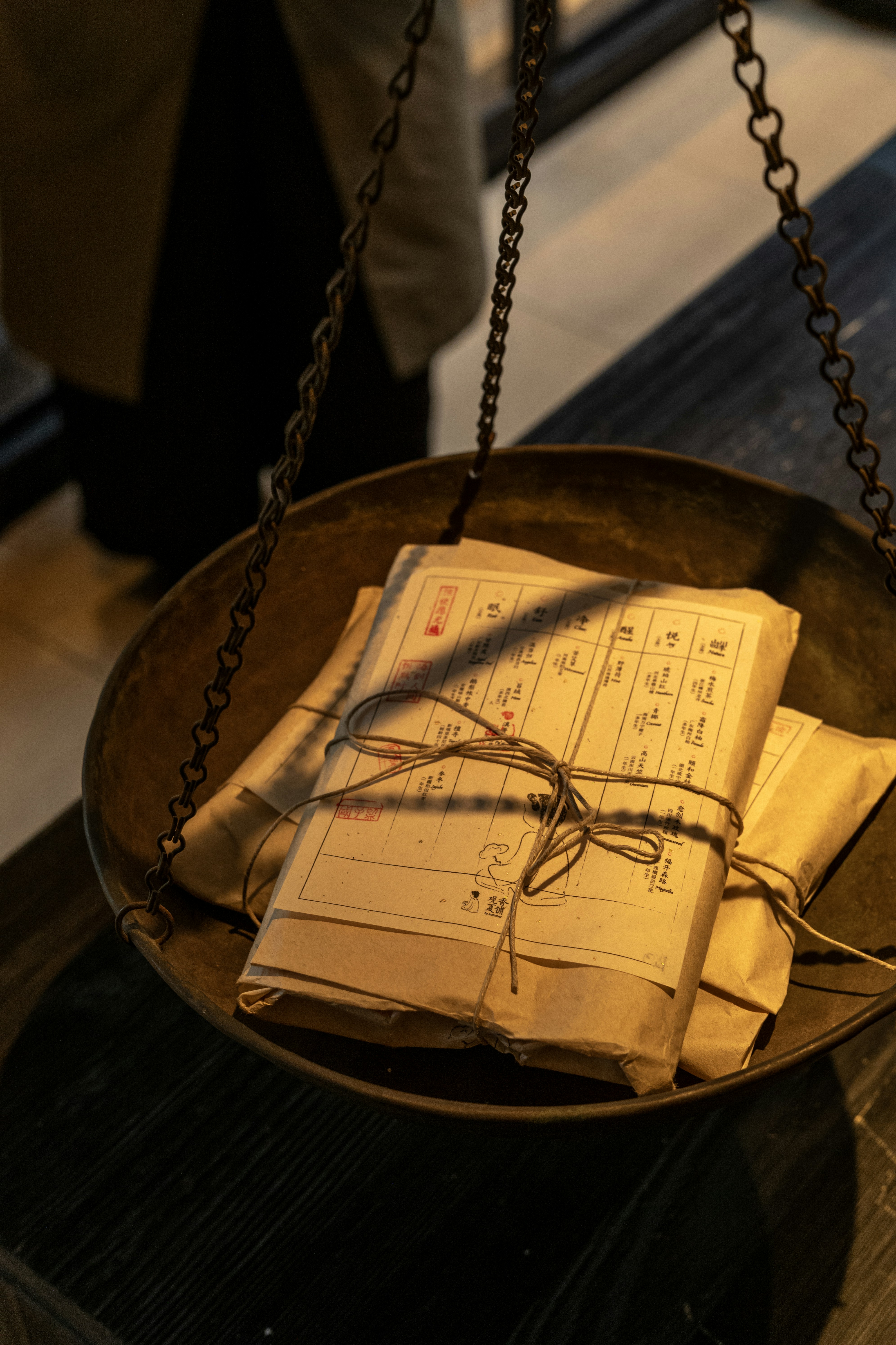Bronze balance: a vintage package resting in a suspended scale