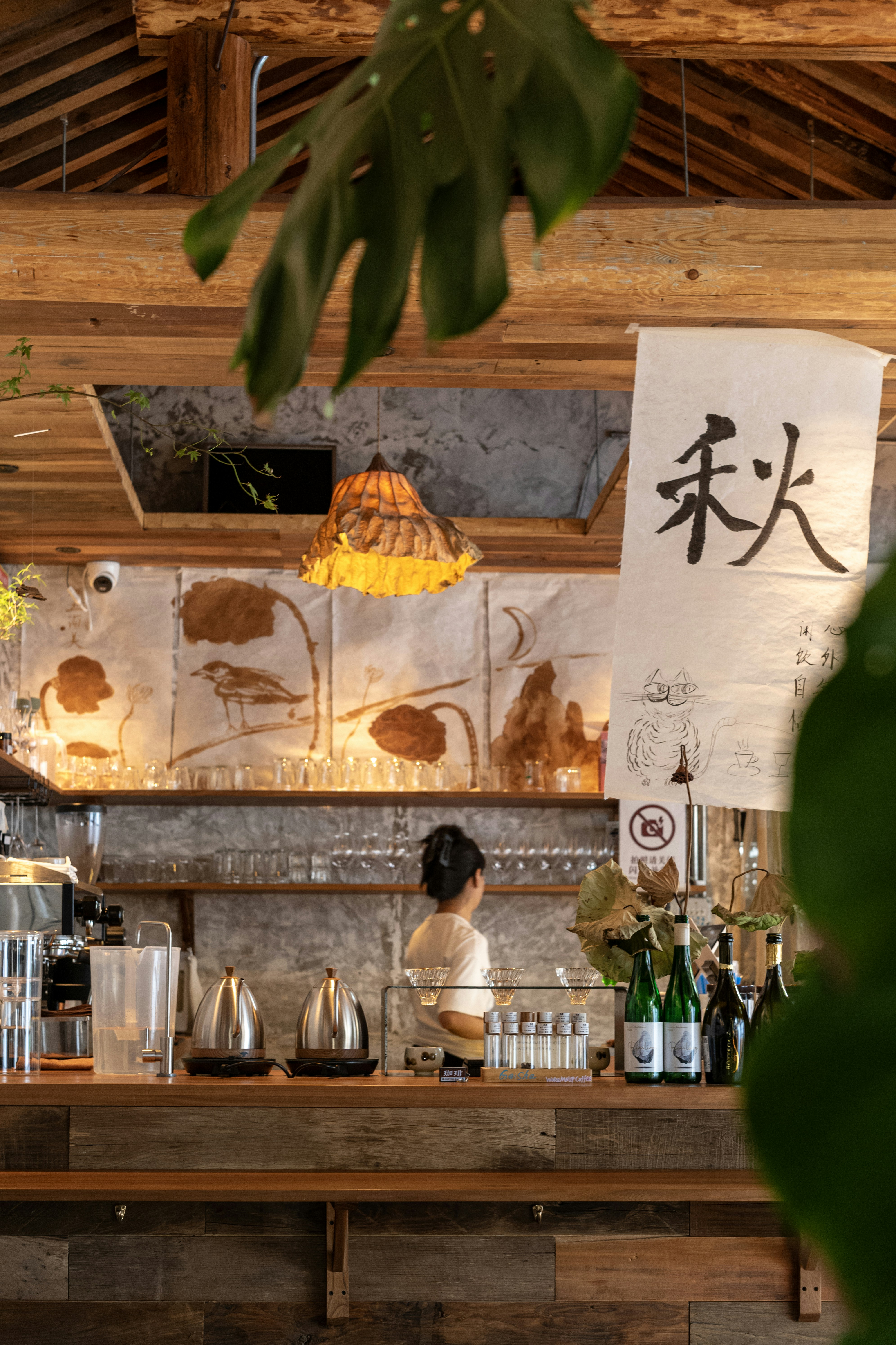Warm Wooden Café Interior with Bar Counter and Hanging Lantern