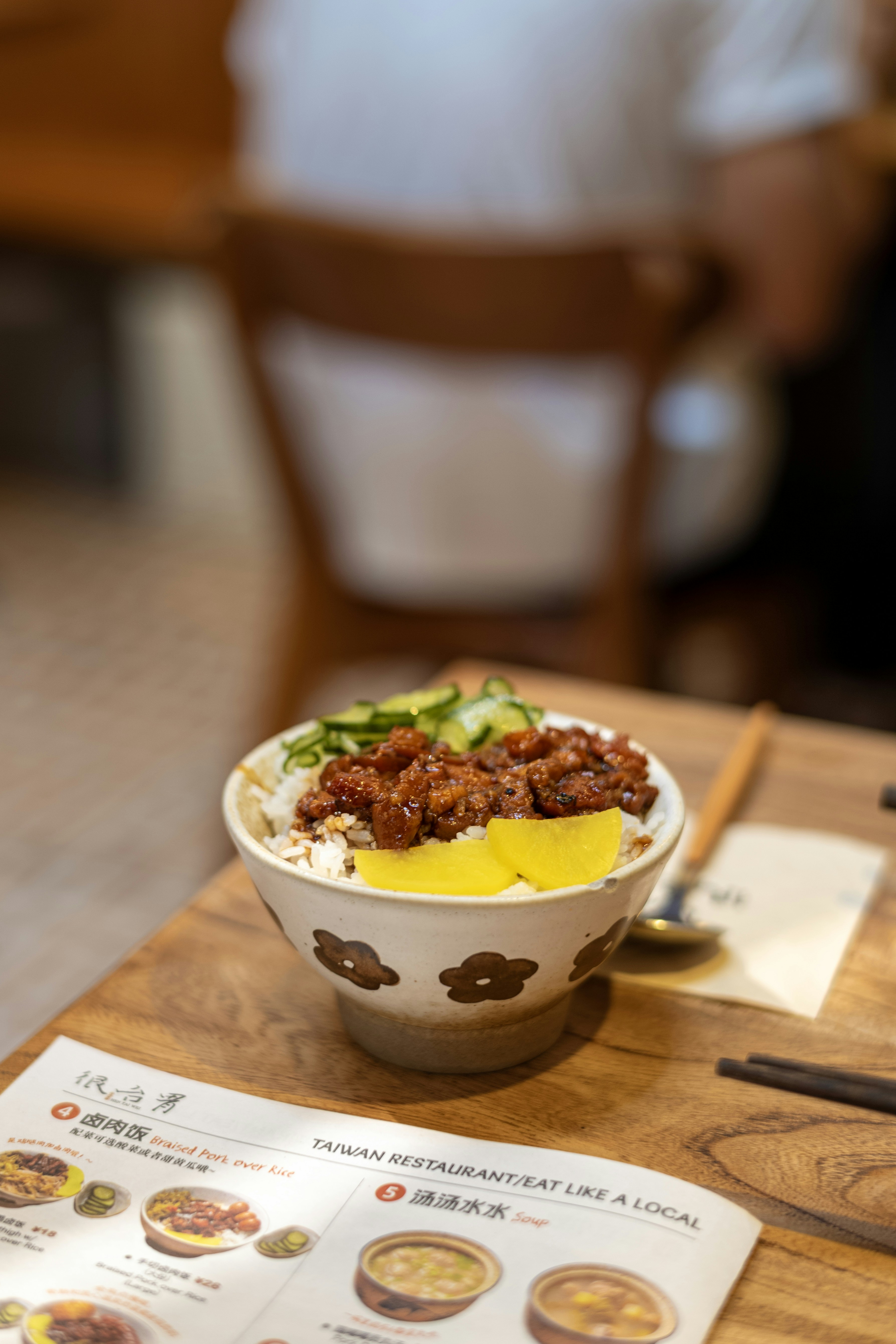 Bowl of glossy beef over rice draws the eye at a cozy restaurant
