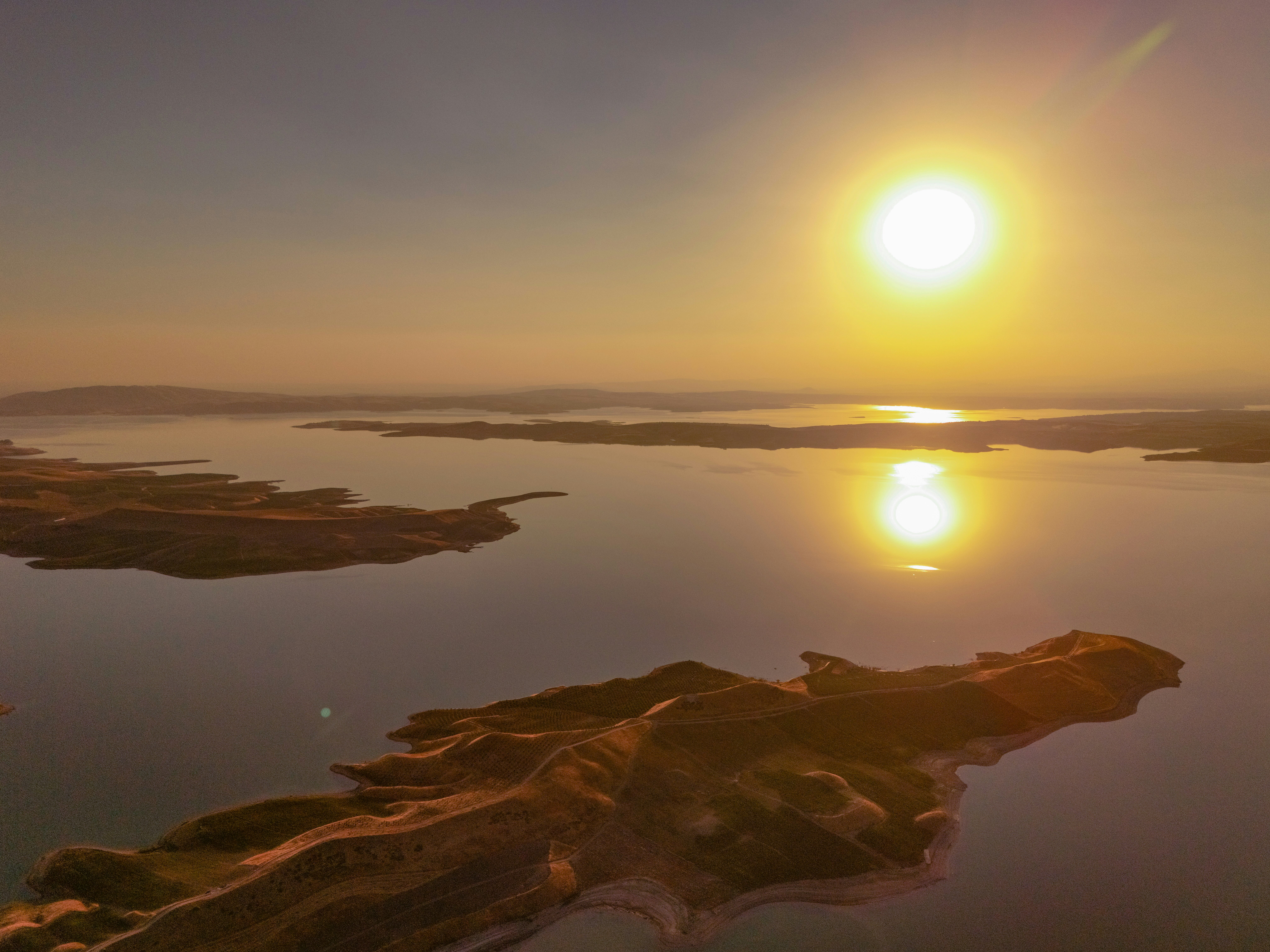 Sunlit Islands: A Quiet Horizon over Glassy Water