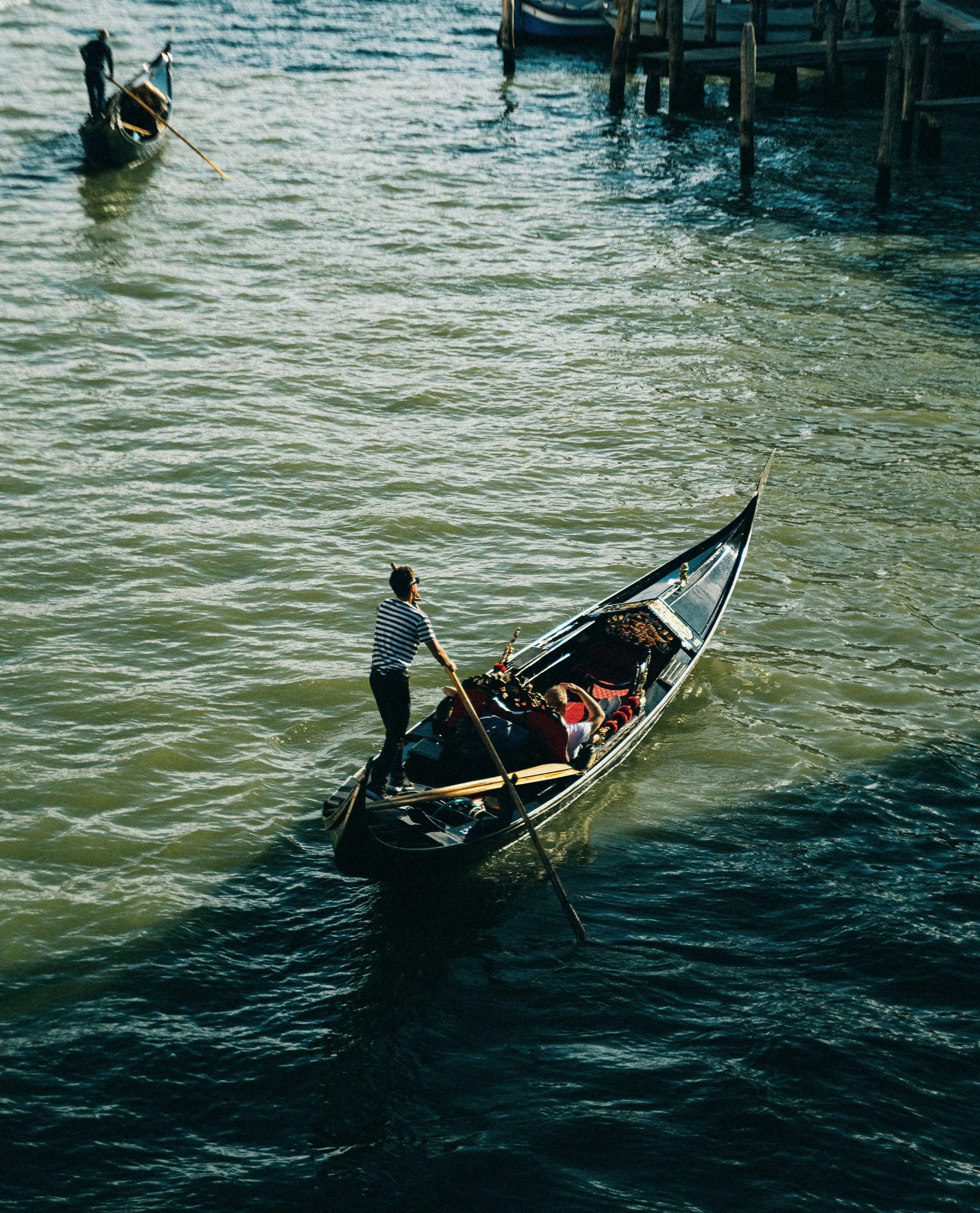 Gondola Ascent: A Lone Row Across Quiet Waters