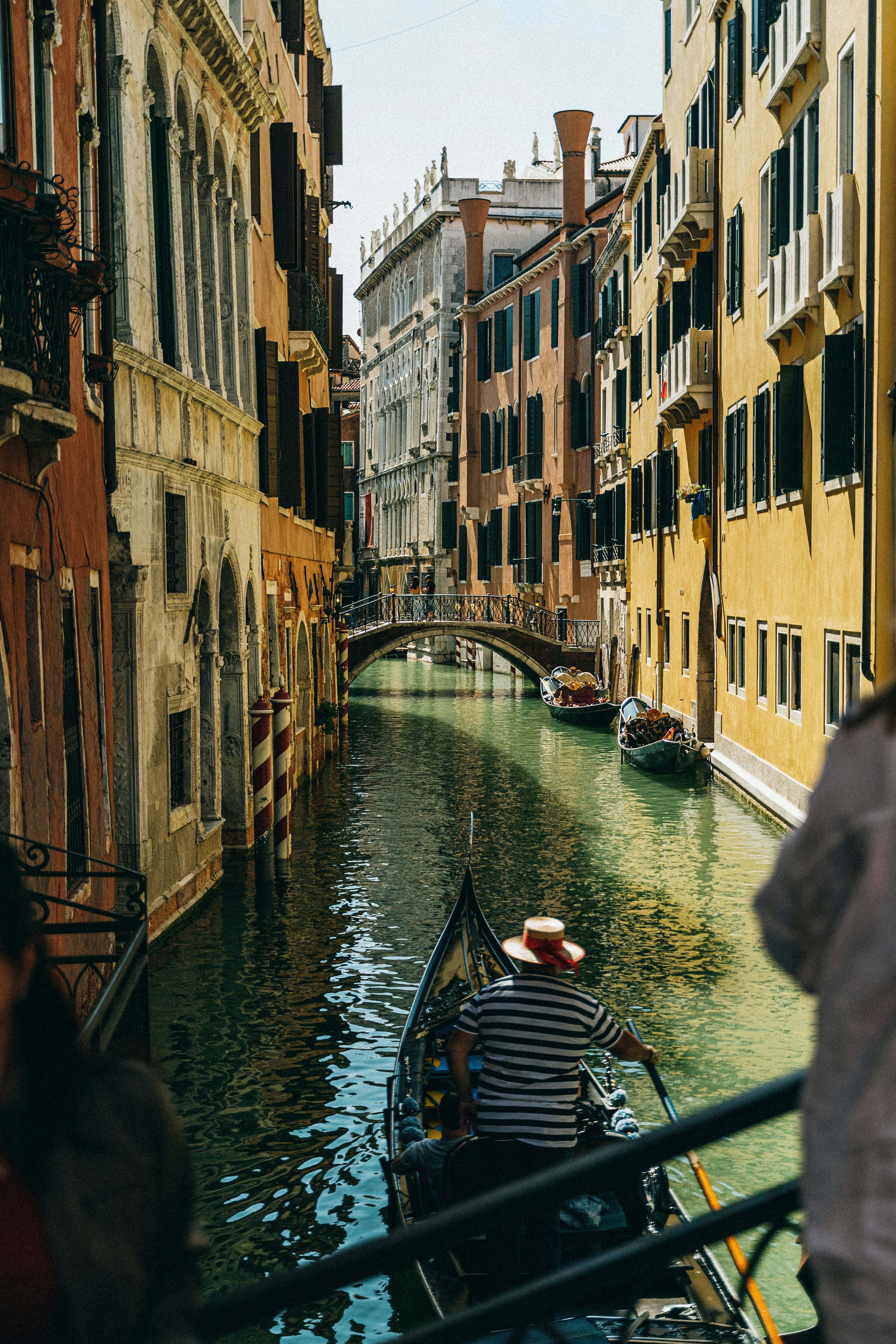 Gondola Passage Through a Sunlit Venetian Canal