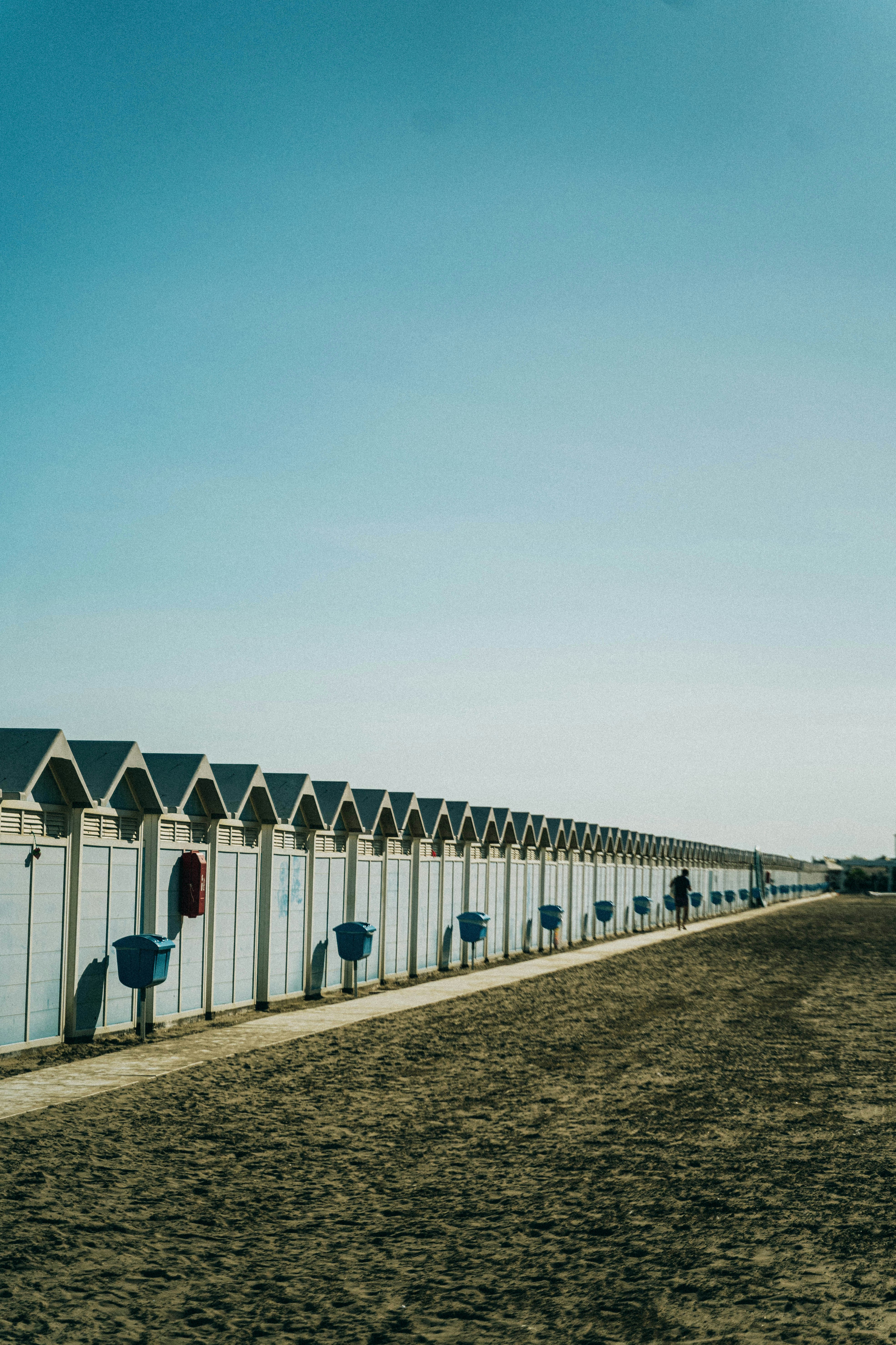 Row of Beachfront Cabins Fading into the Horizon