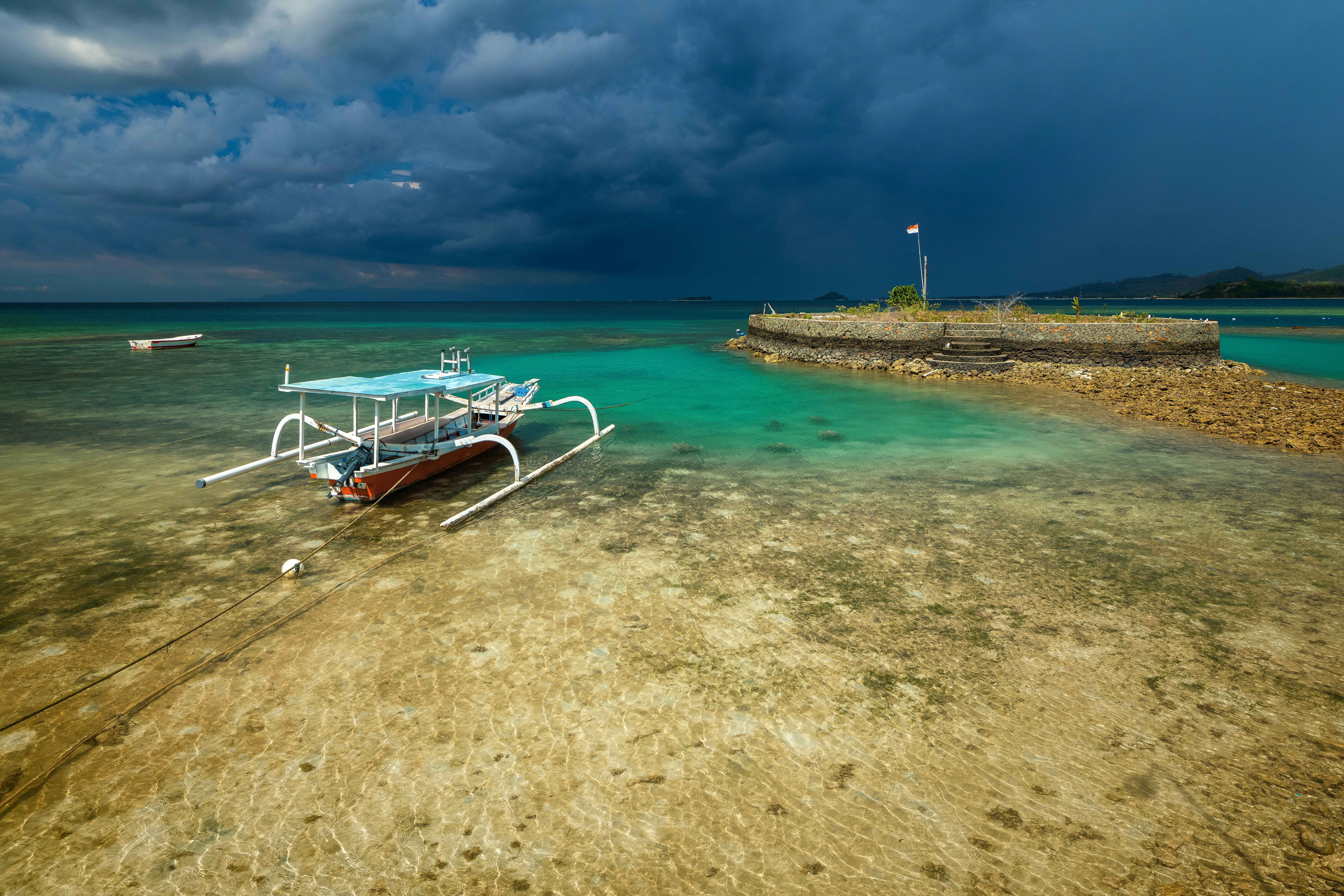 Iridescent Shore: Boat Barque at the Edge of Turquoise Waters