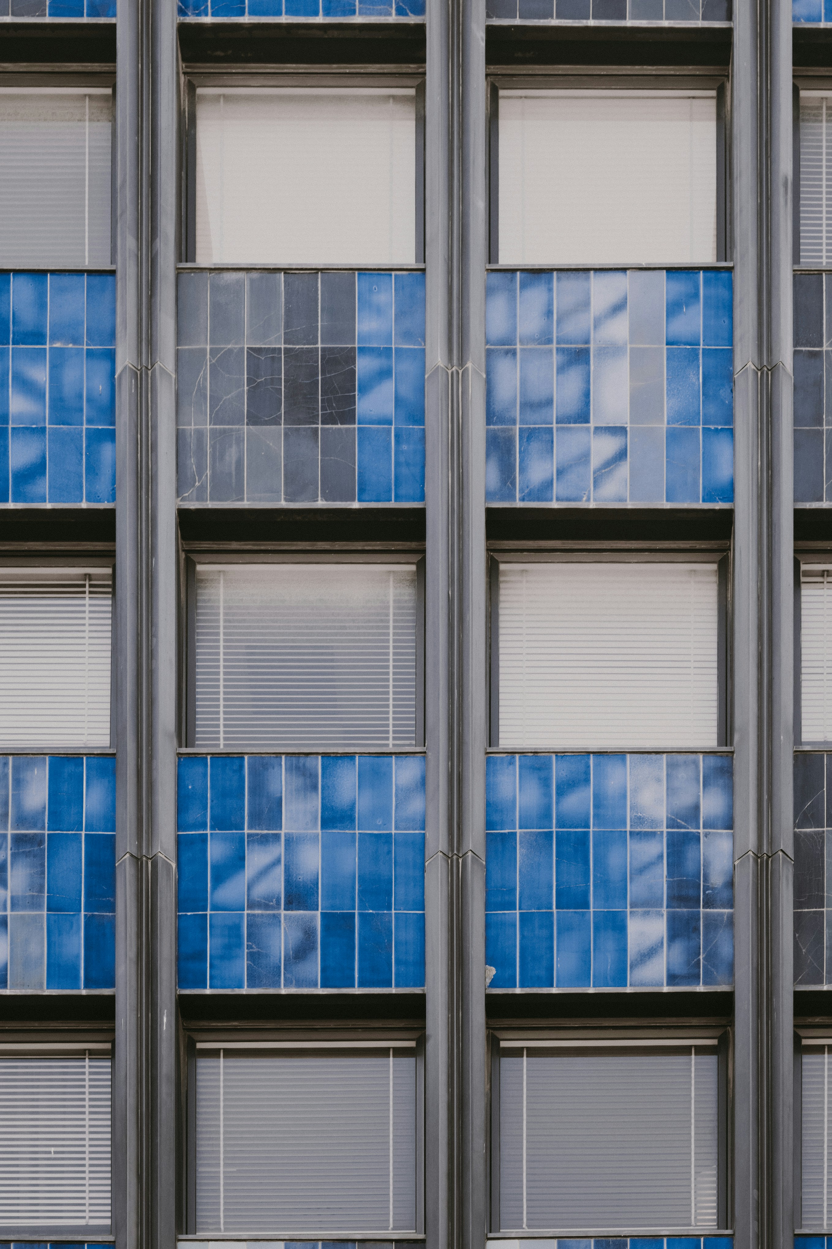Blue Tile Facade: Vertical Strips of Glass and Metal