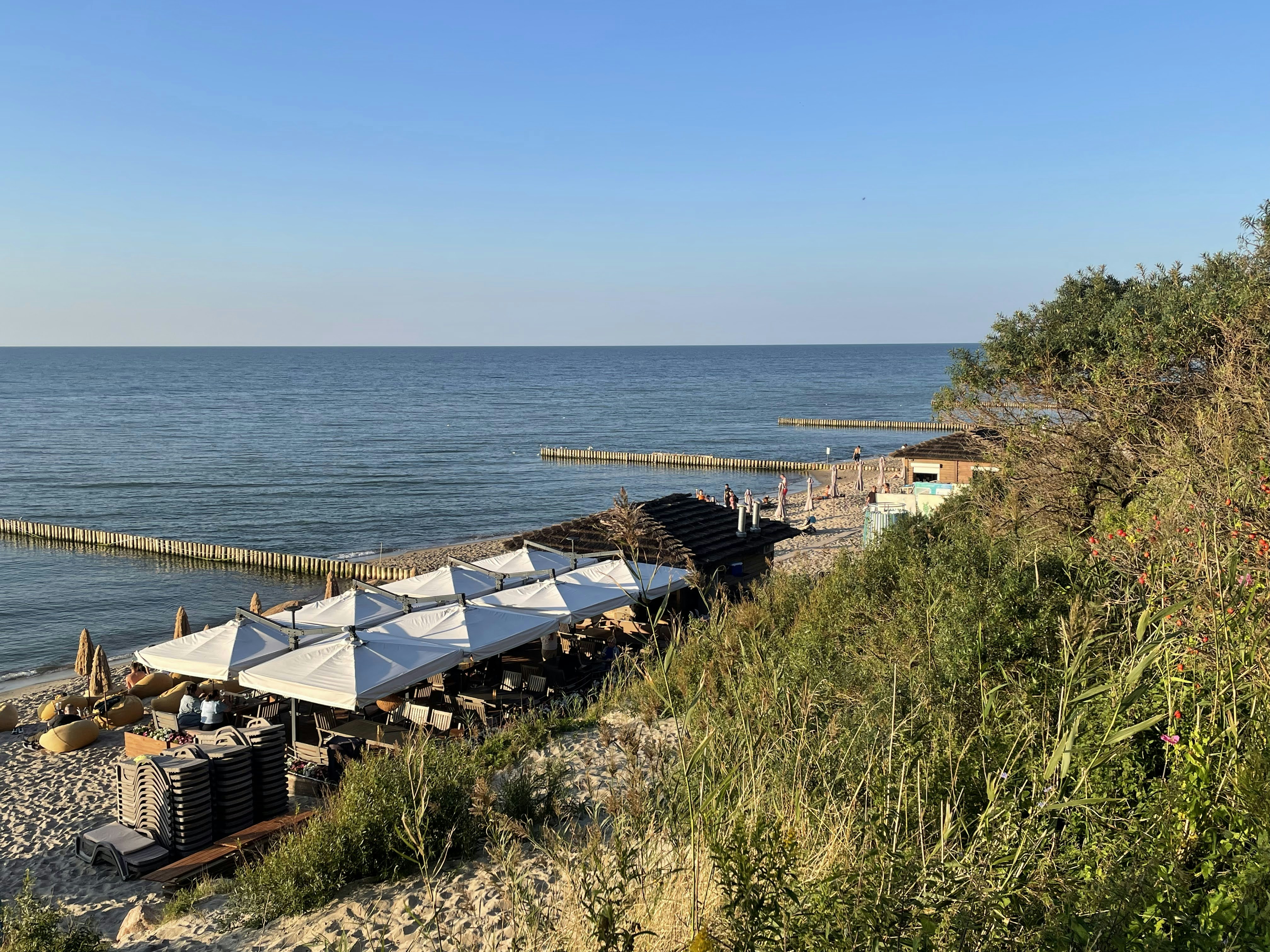 Row of Beach Umbrellas and Docks by the Blue Sea