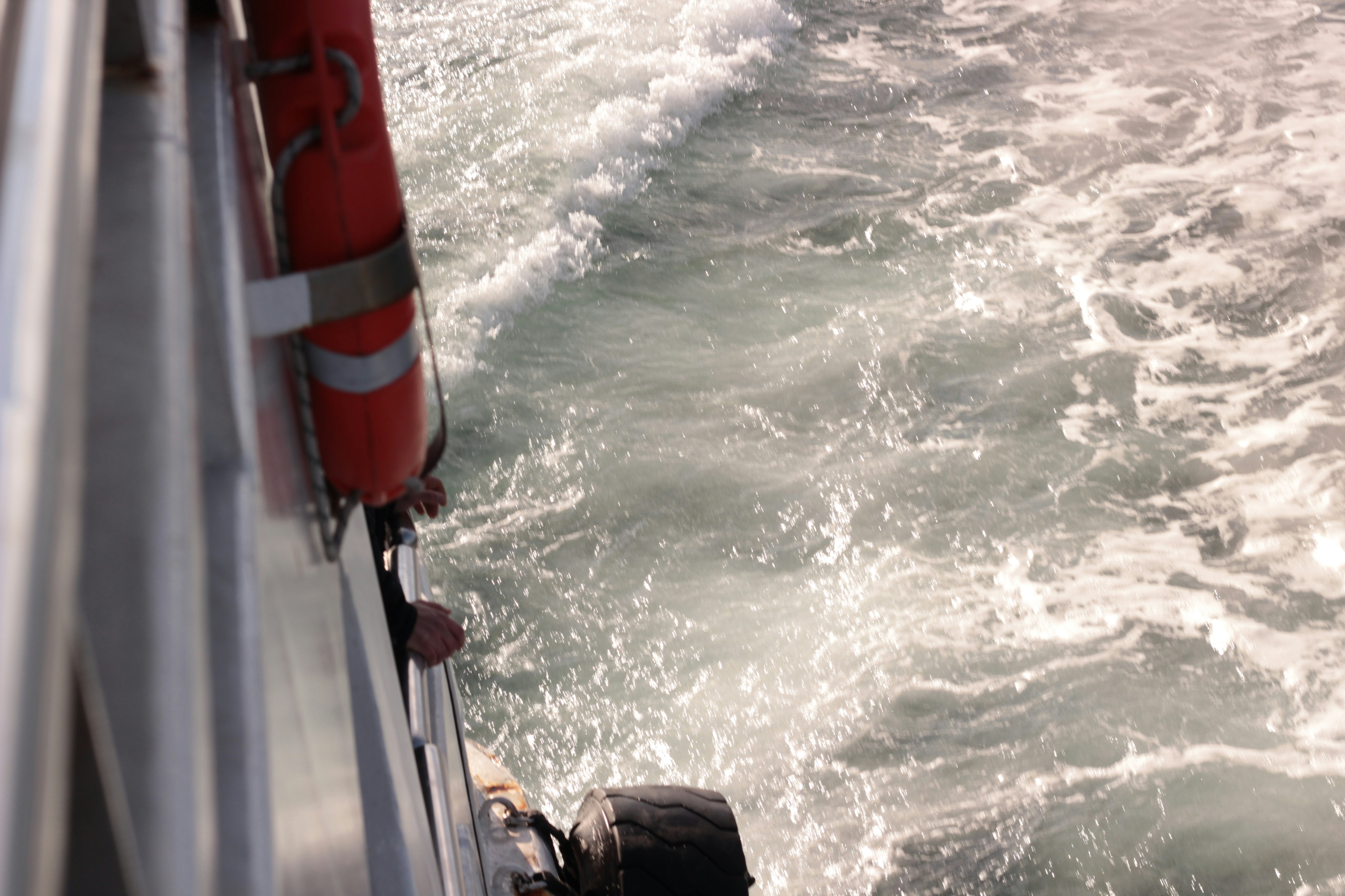Over the Bow: Lifebuoy and Wake Along a Coastal Deck