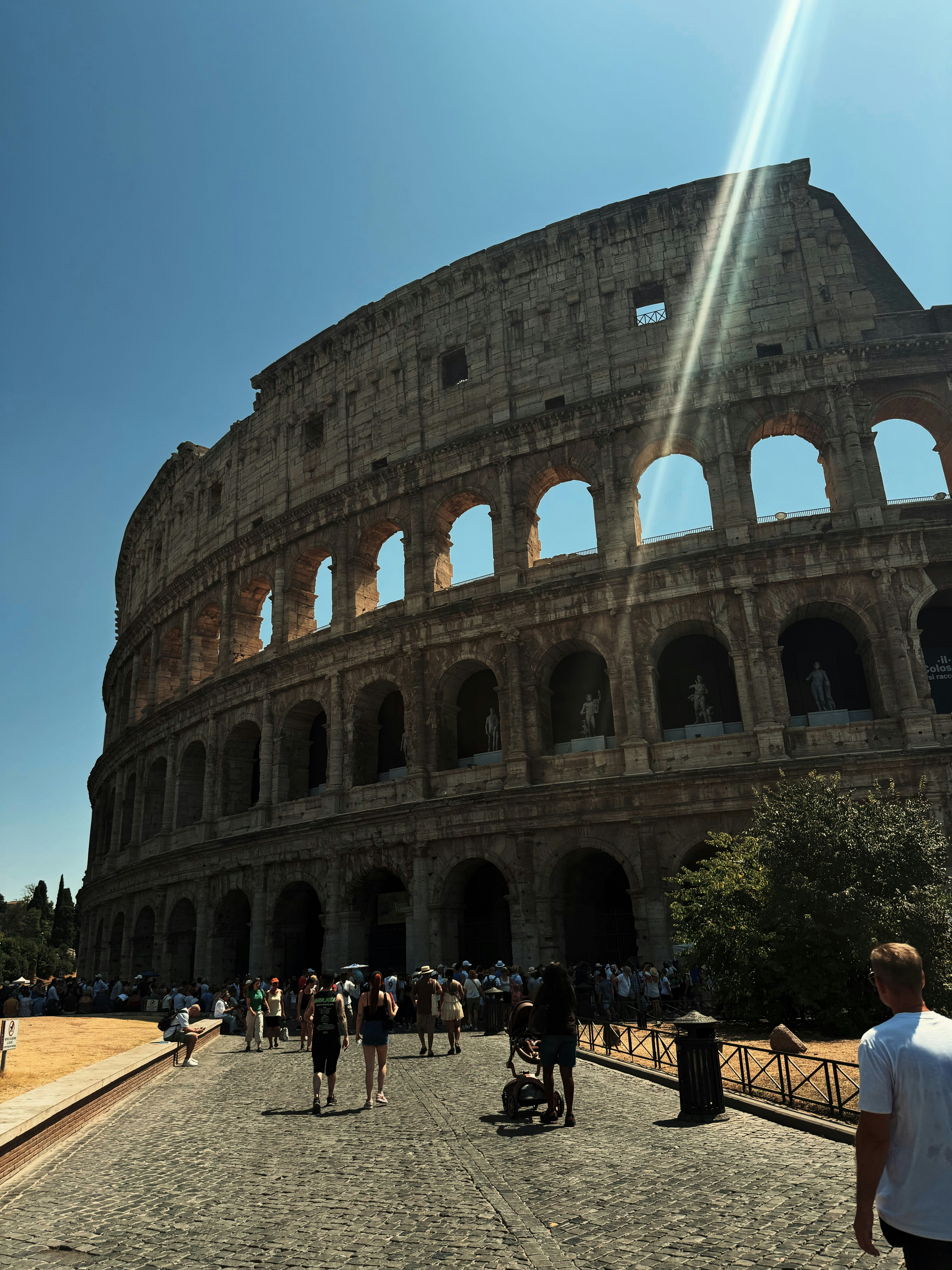 Colossal Amphitheater Under a Sunlit Arc
