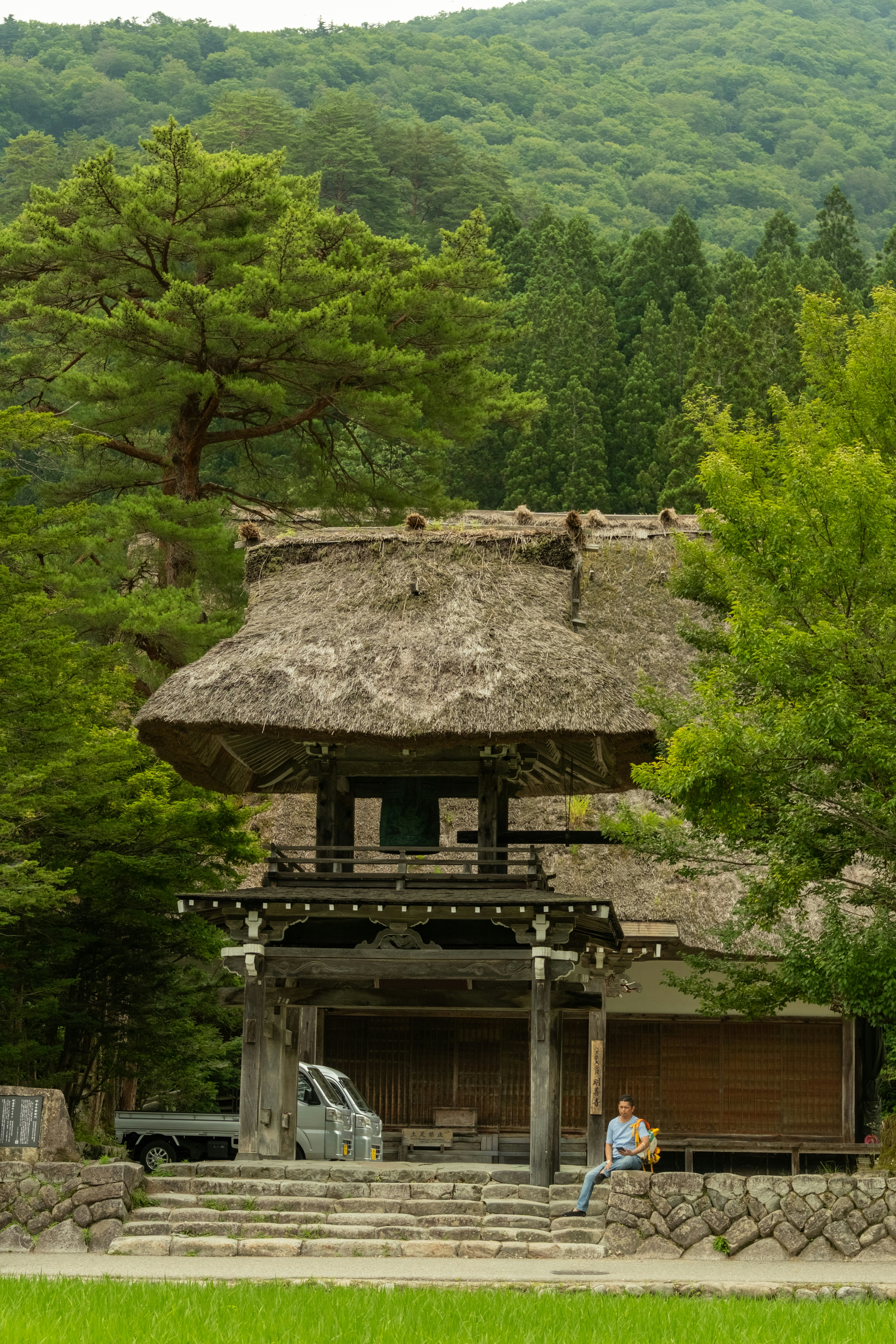 Thatched Gatekeeper: a quiet moment by the temple doorway