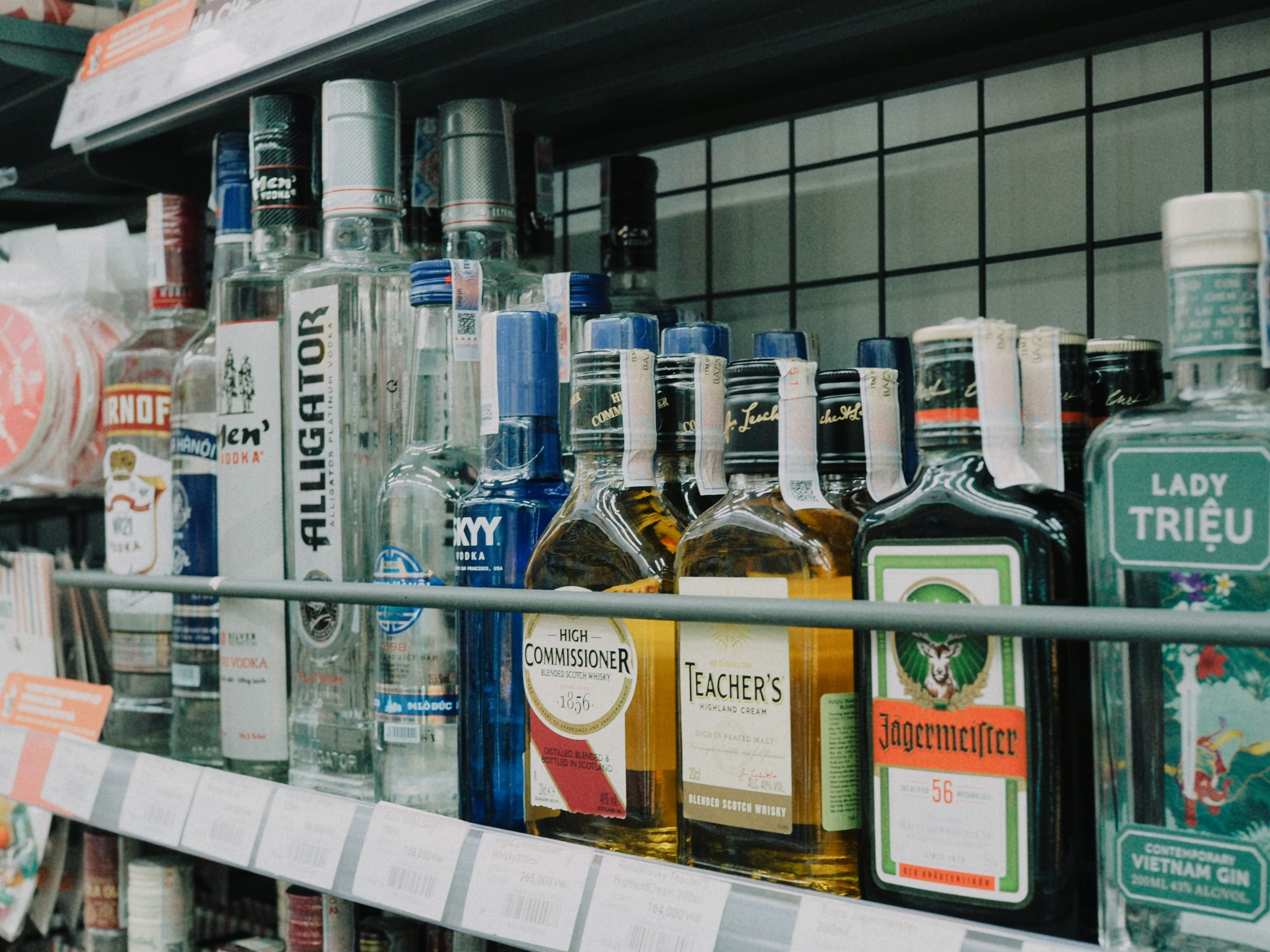 Row of amber and clear bottles: a compact liquor aisle snapshot